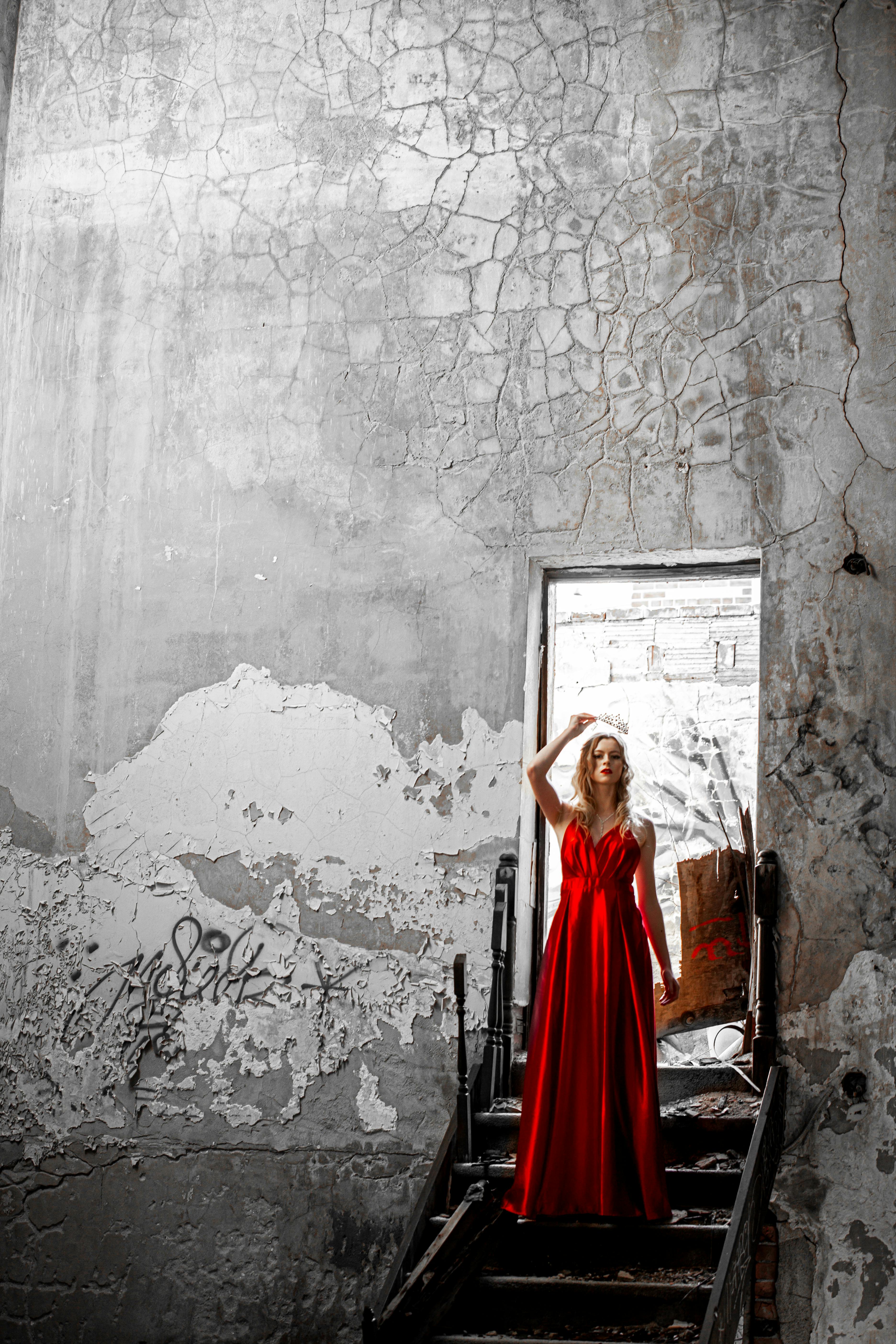 A Woman in Red Dress Standing on Stair · Free Stock Photo