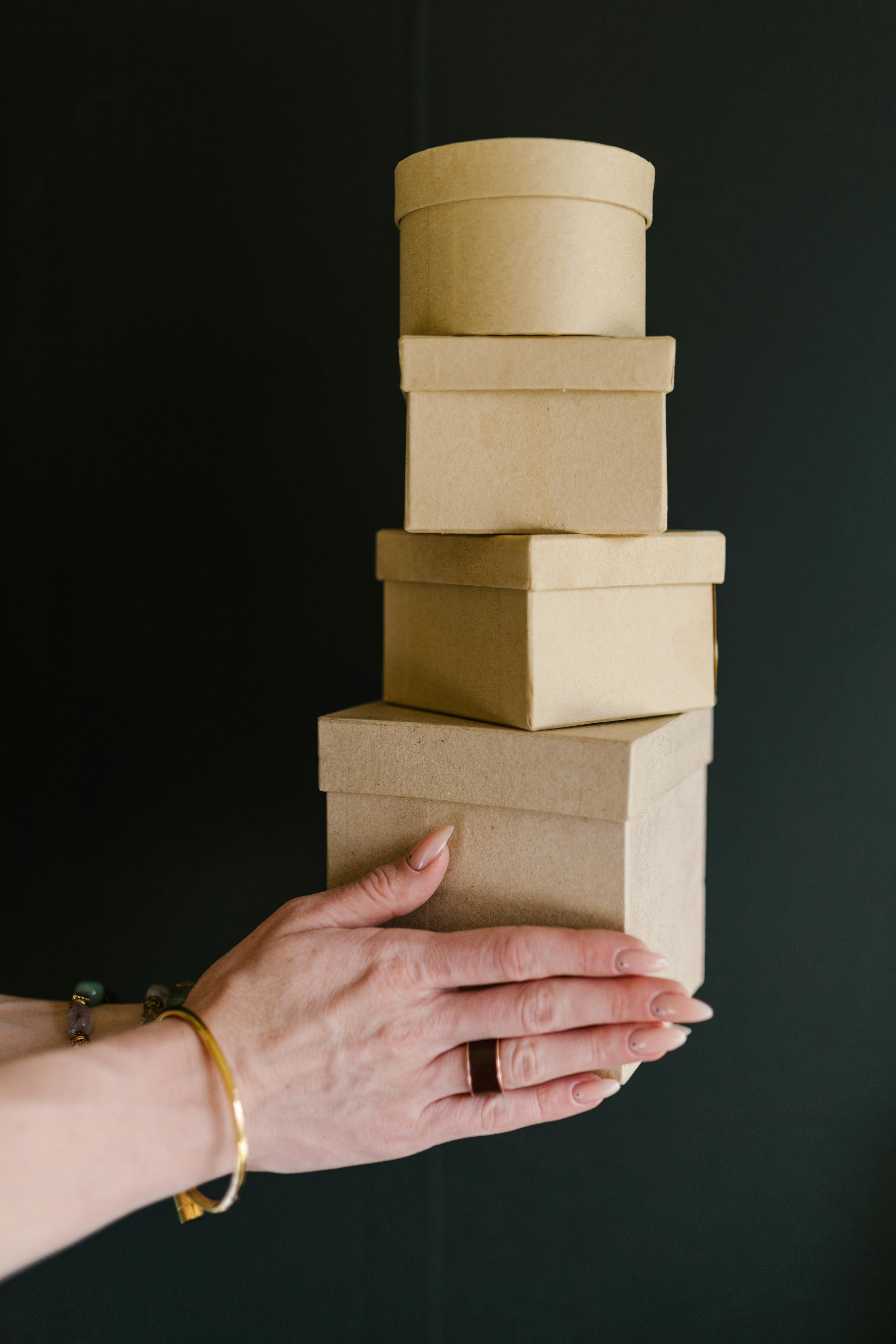 A Person Carrying a Stack of Boxes · Free Stock Photo