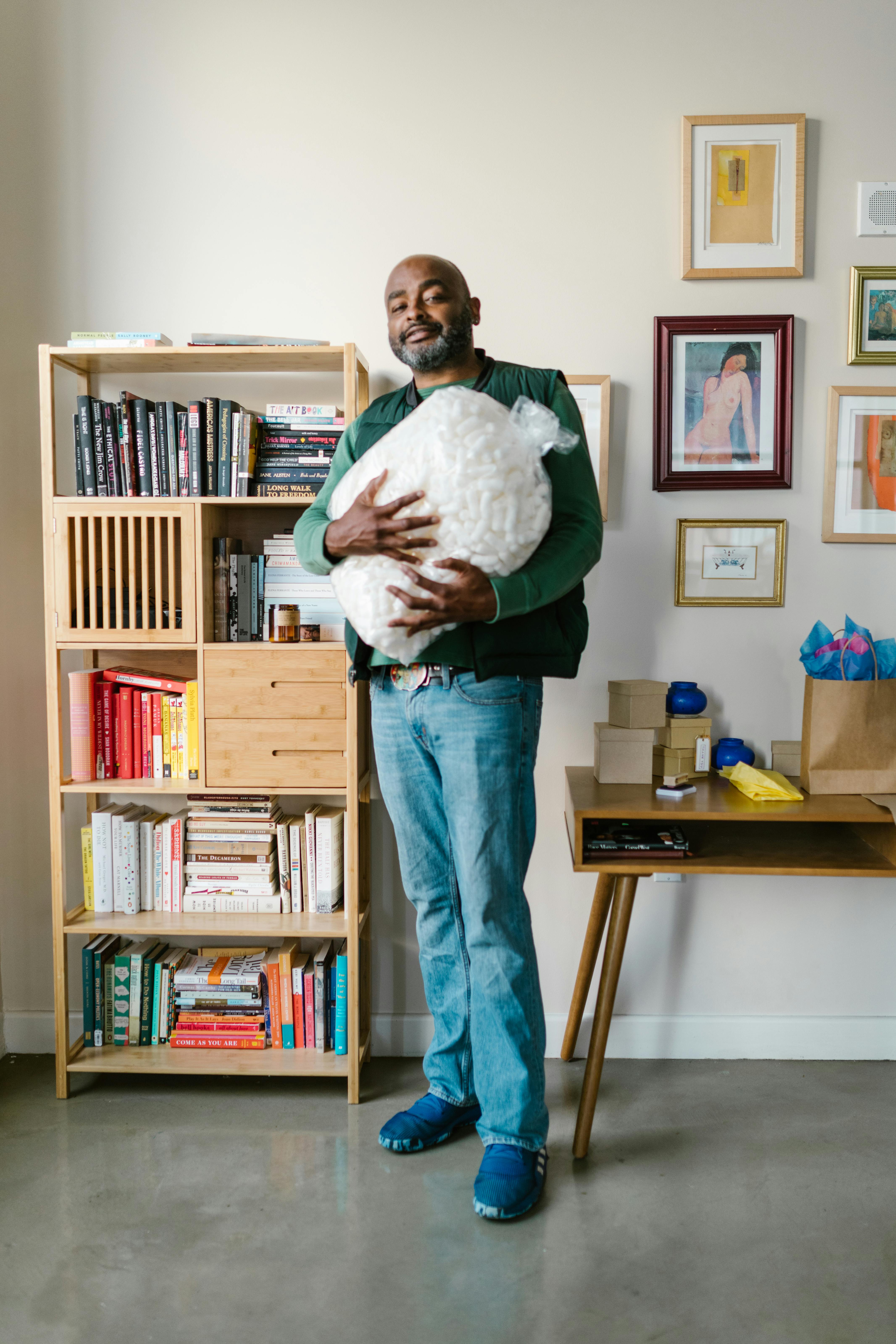 Man Standing and Holding a Bag of Styro Foams · Free Stock Photo