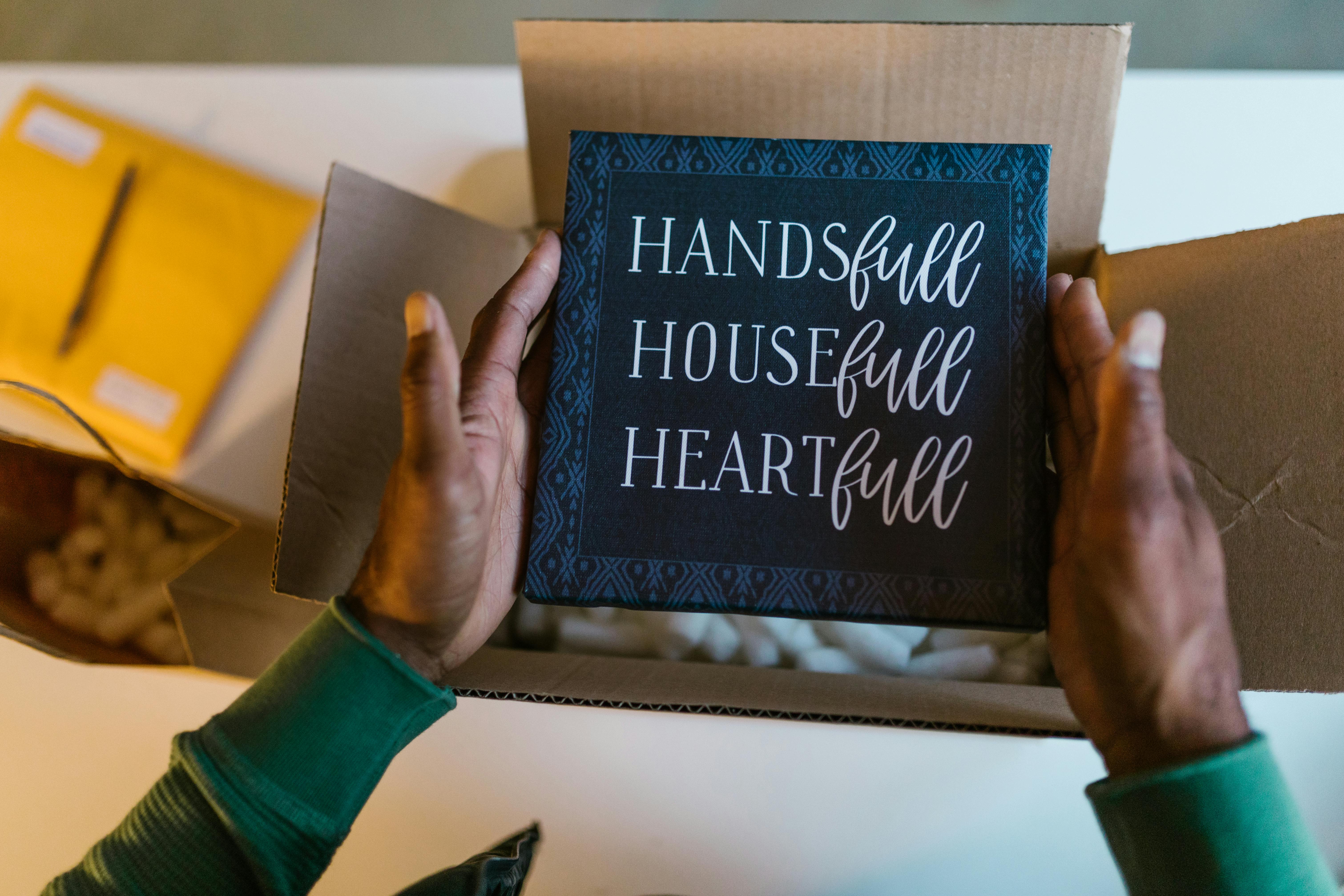 Close-Up Shot of a Person Holding a Box · Free Stock Photo
