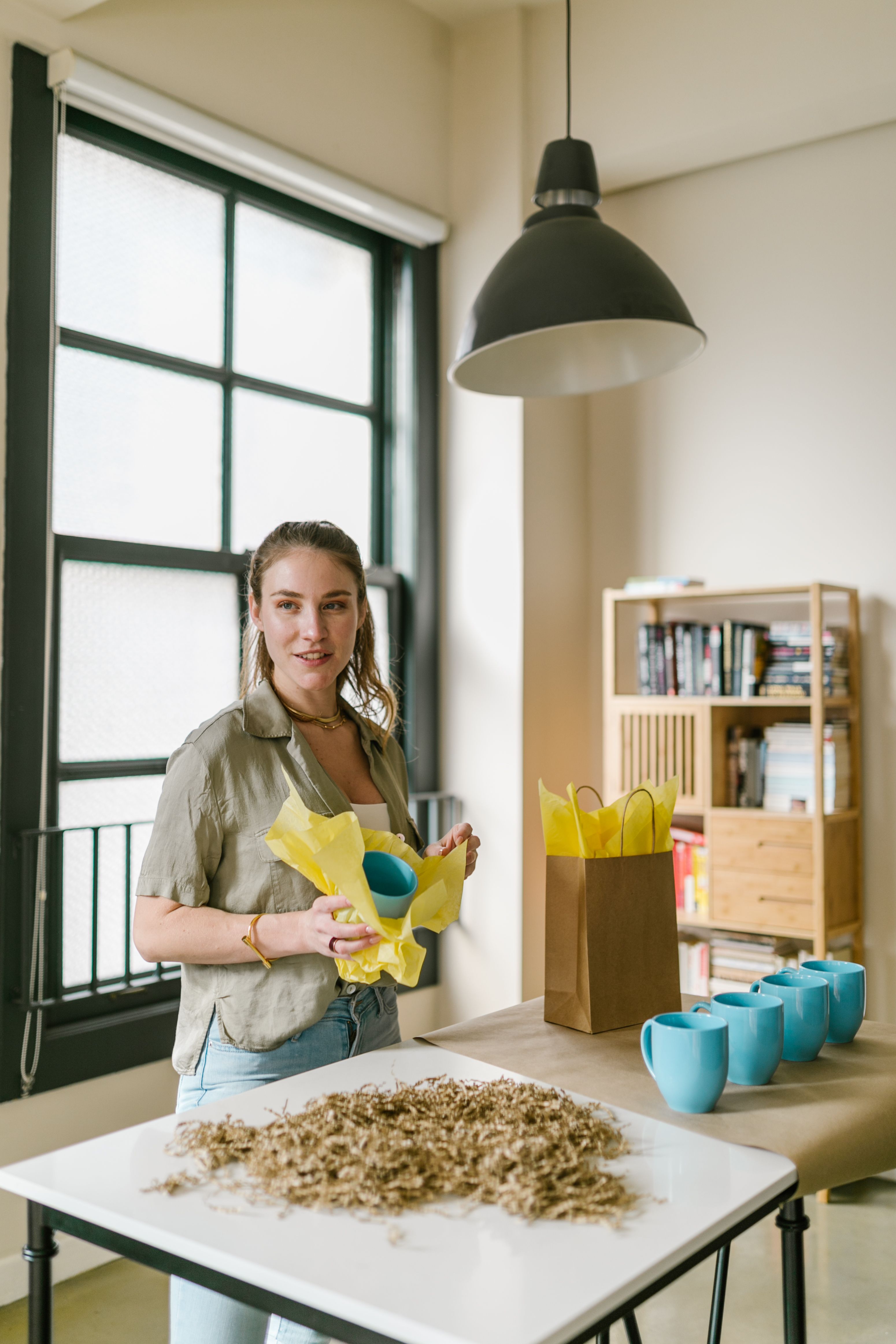 Woman Choosing Wrapping Paper · Free Stock Photo