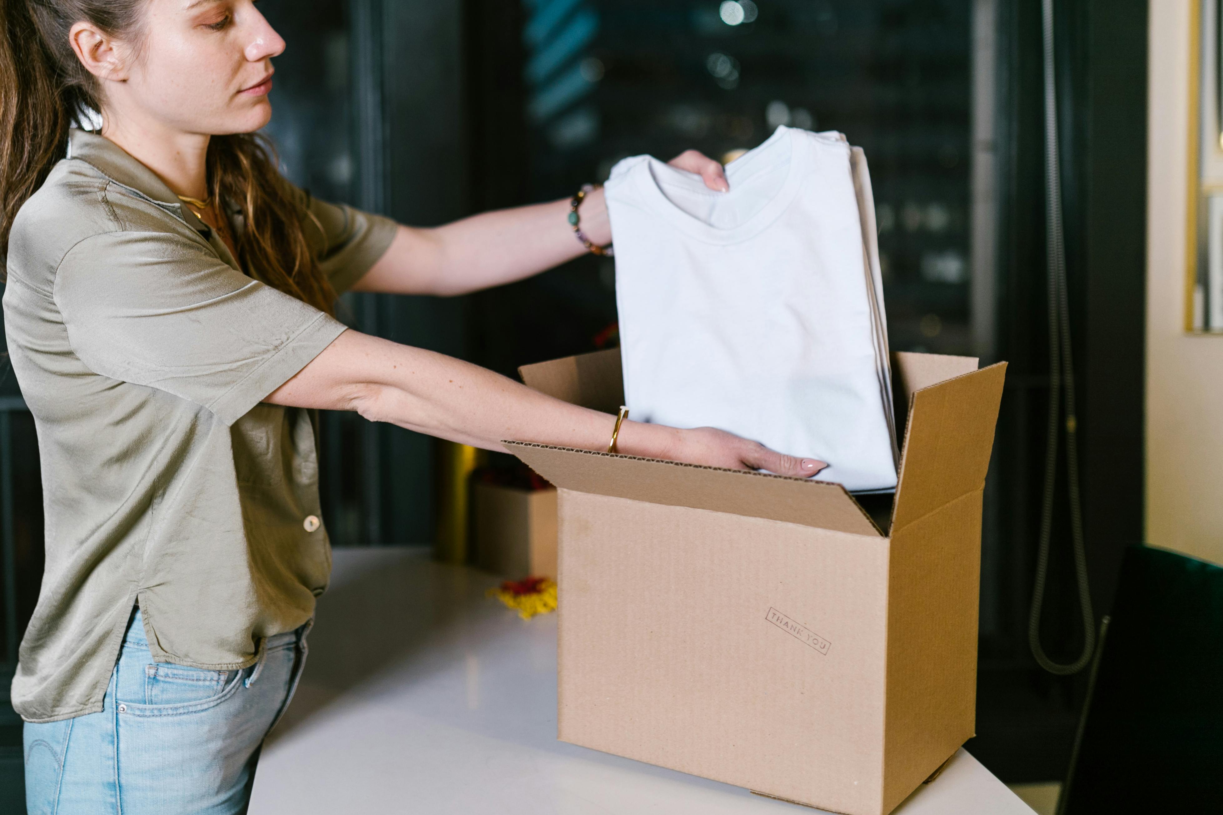 Close-Up Shot of a Person Putting Tape on a Cardboard Box · Free Stock ...
