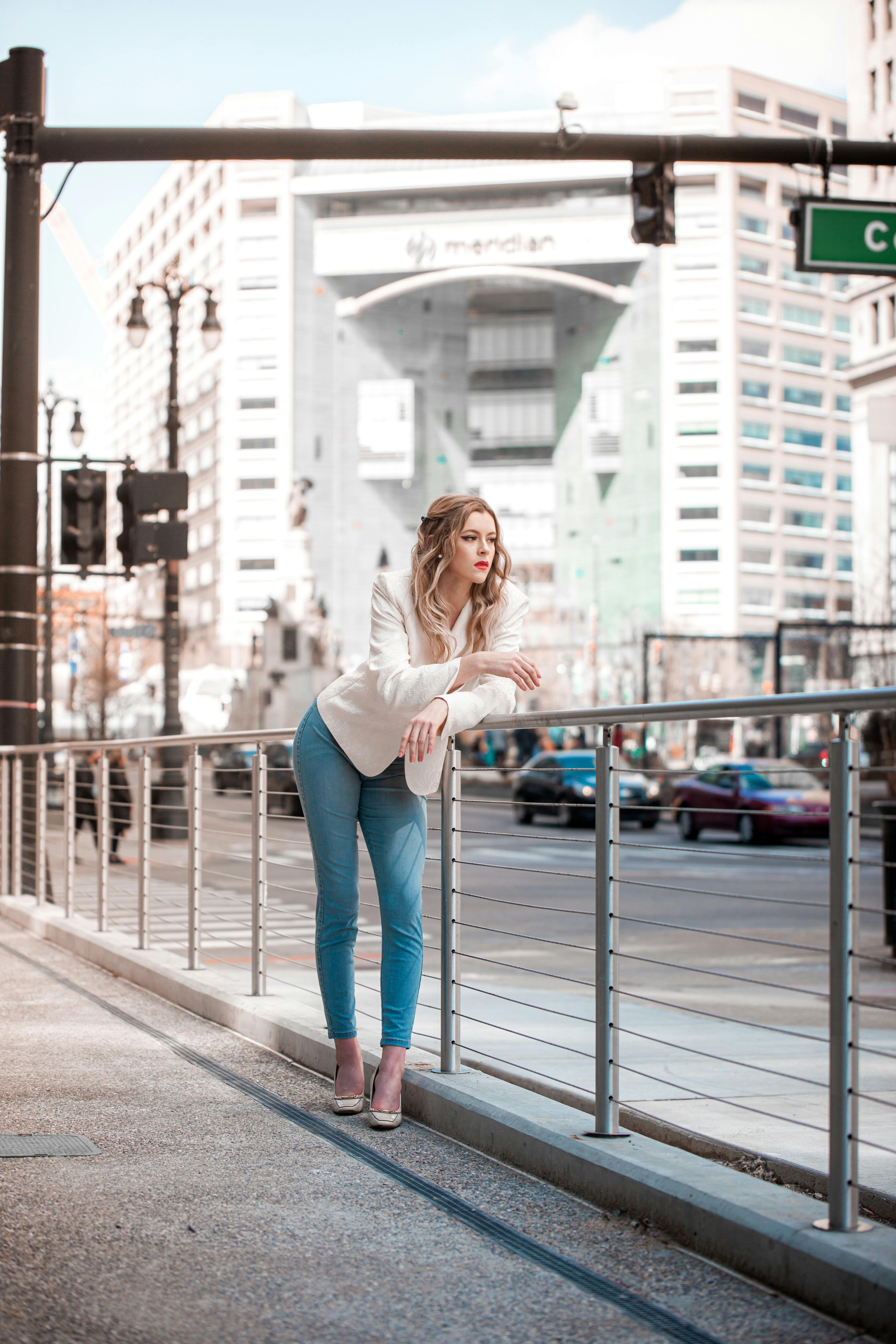 A Woman Leaning on the Metal Railings · Free Stock Photo