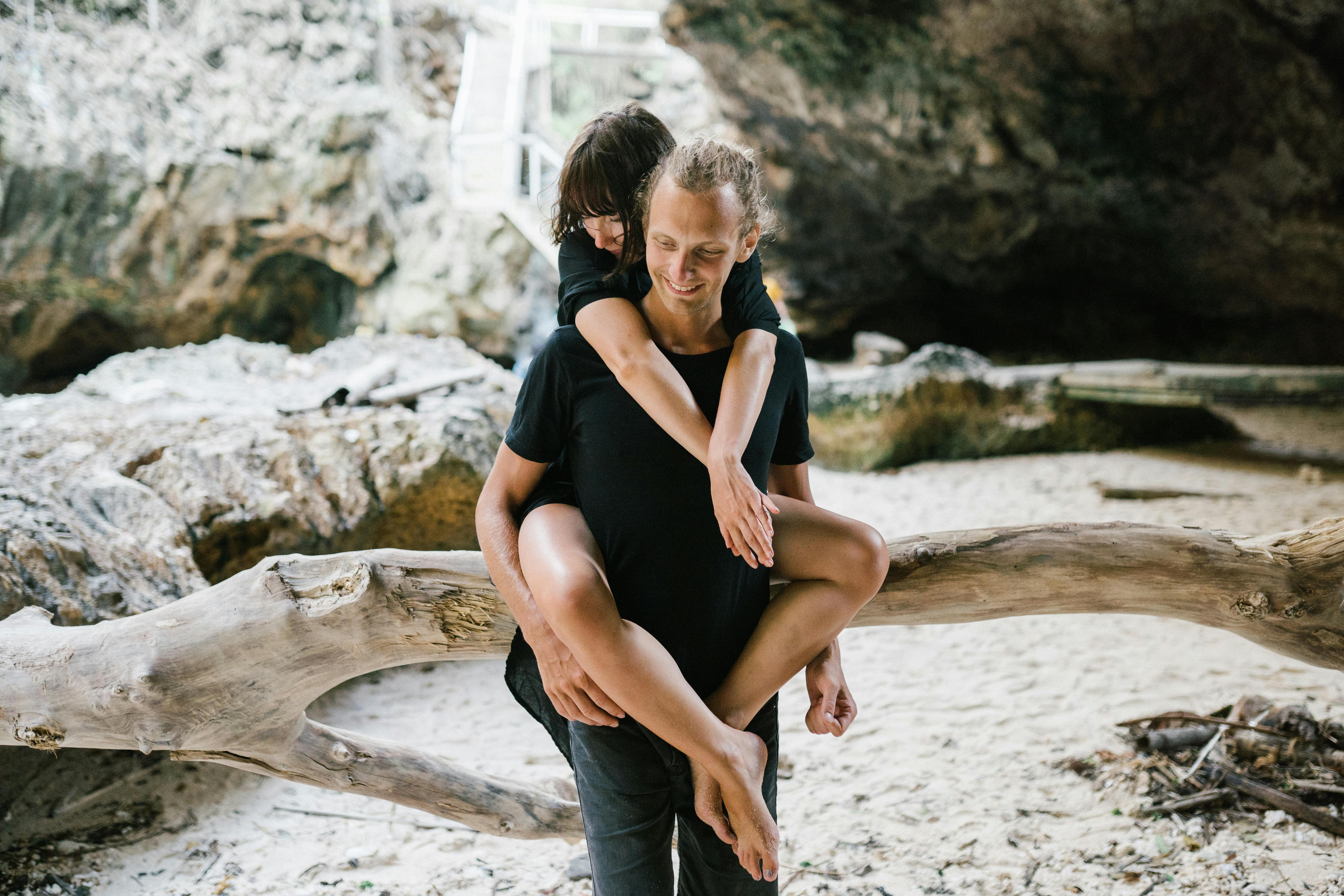 Man Carrying a Woman on His Back · Free Stock Photo