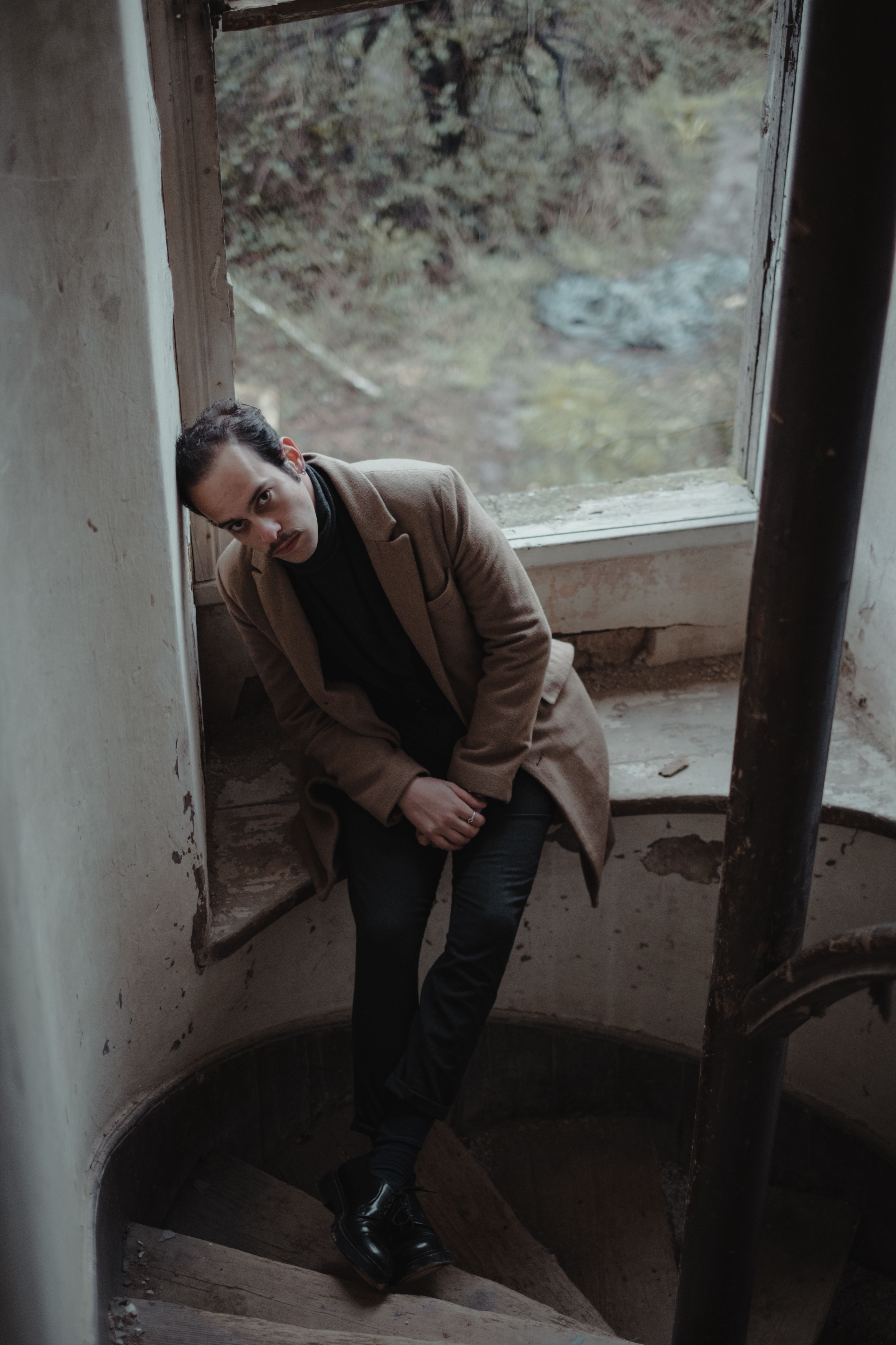 A Man Sitting on the Window Sill · Free Stock Photo