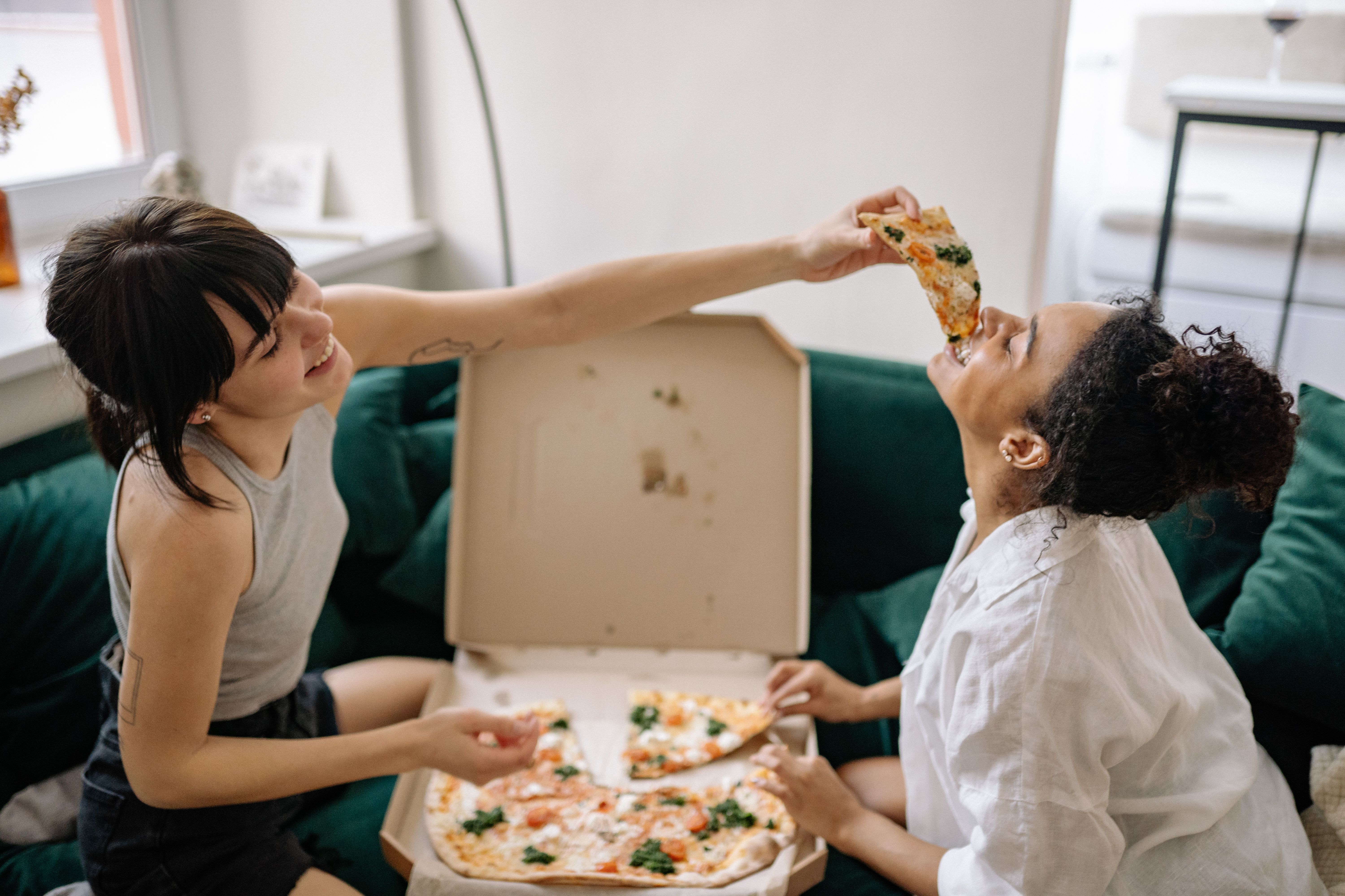 Couple Lying Down Eating Pizza · Free Stock Photo