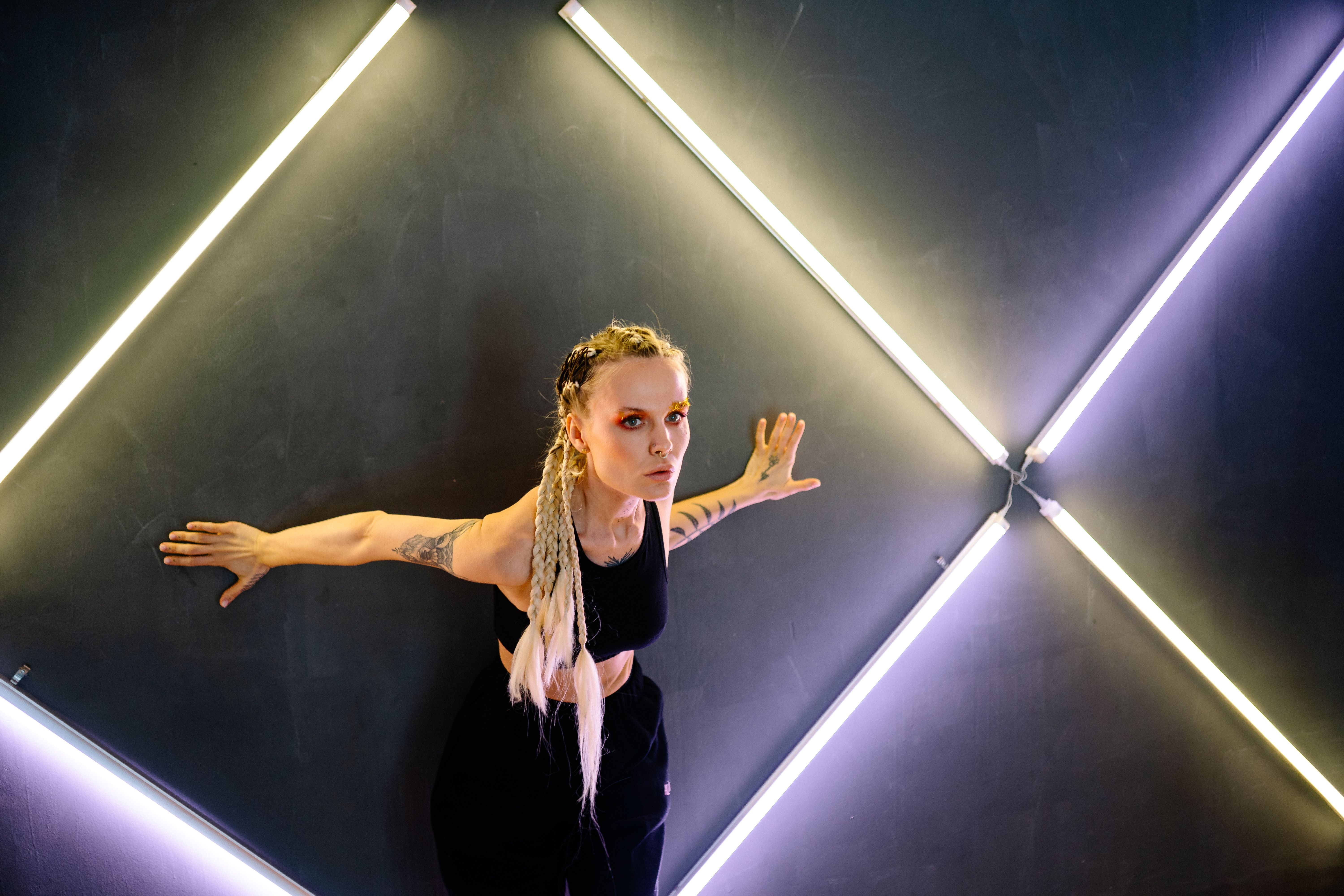 Woman with Long Braided Hair Wearing Black Crop Top Posing Against a ...