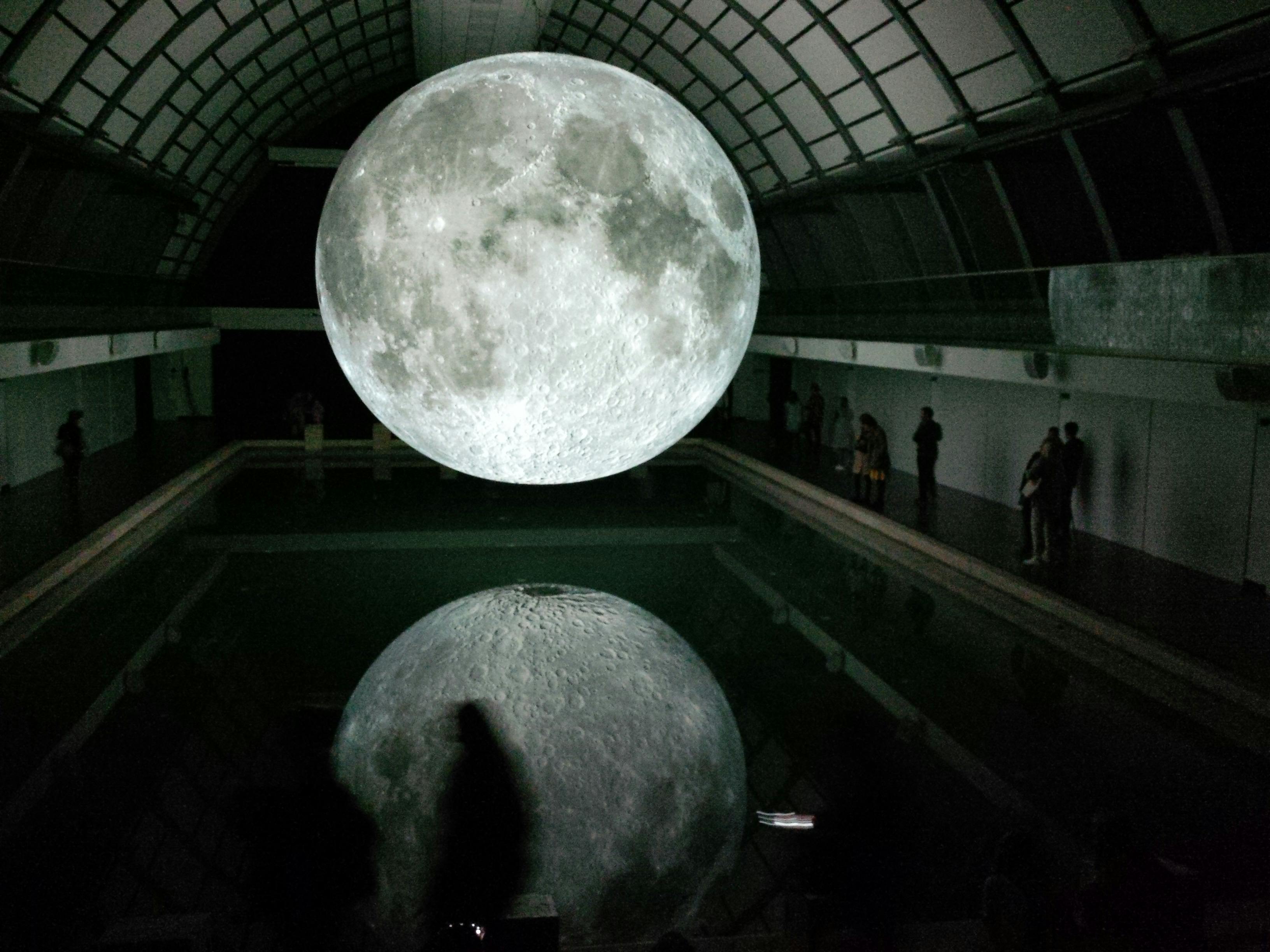 Photo of Moon Hologram Floating on Water Near People Inside Room · Free ...