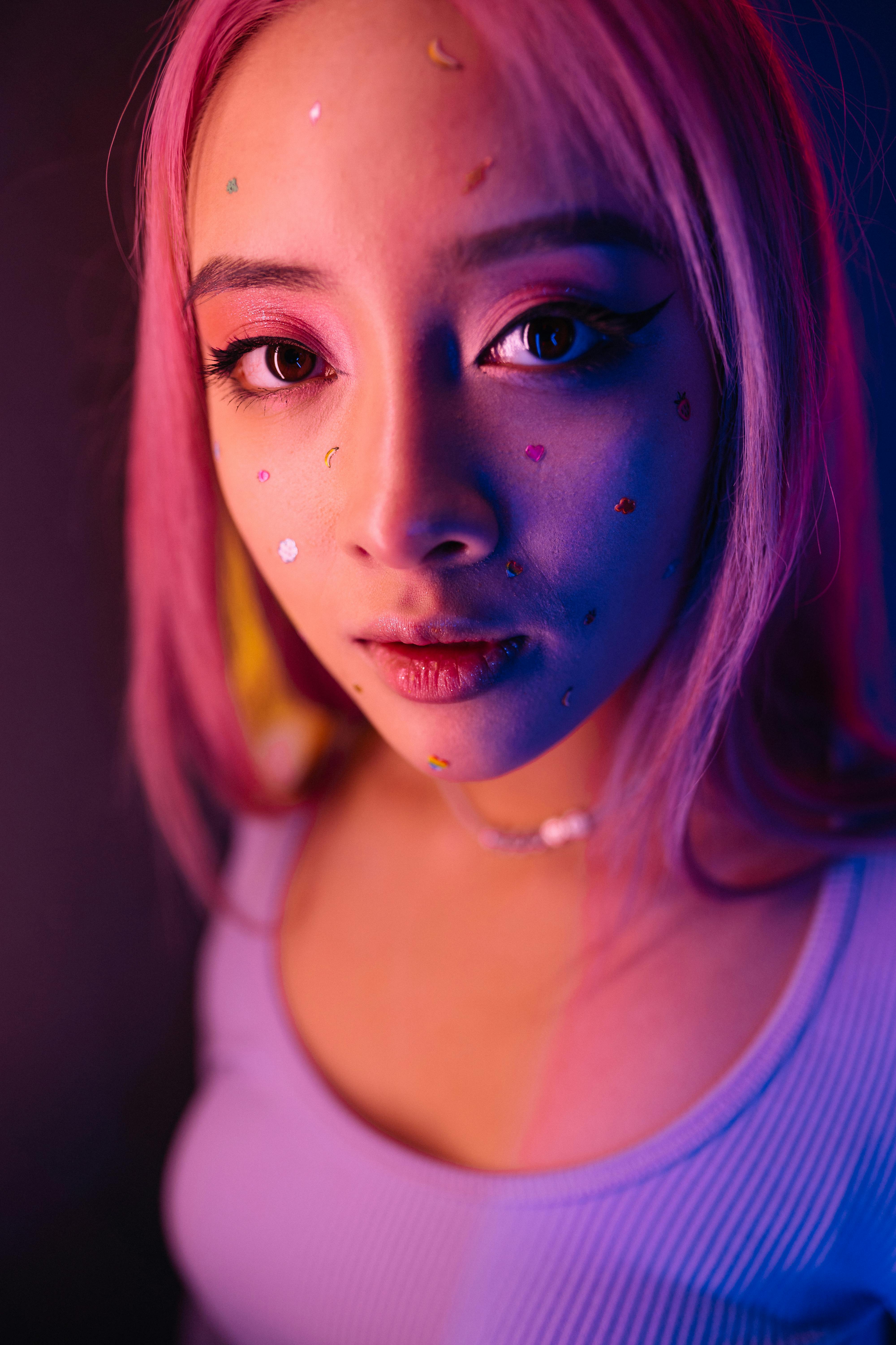 A Woman with Various Stickers on Face · Free Stock Photo