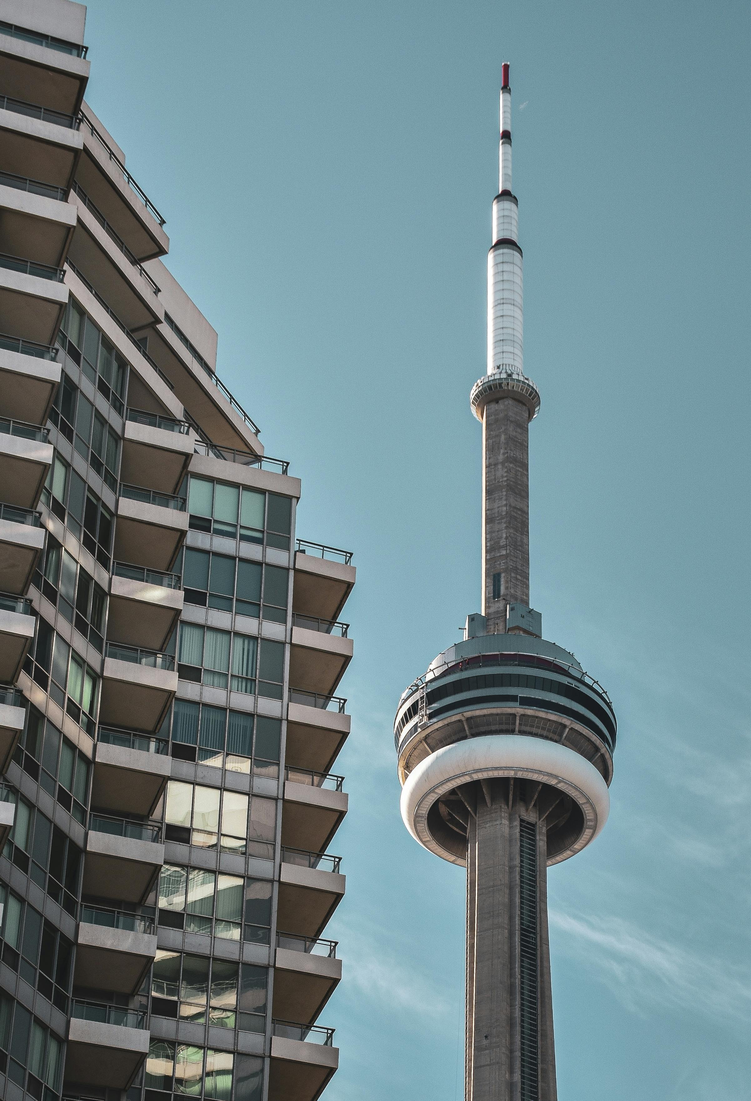 A Building and a Tower in Low-Angle Photography · Free Stock Photo
