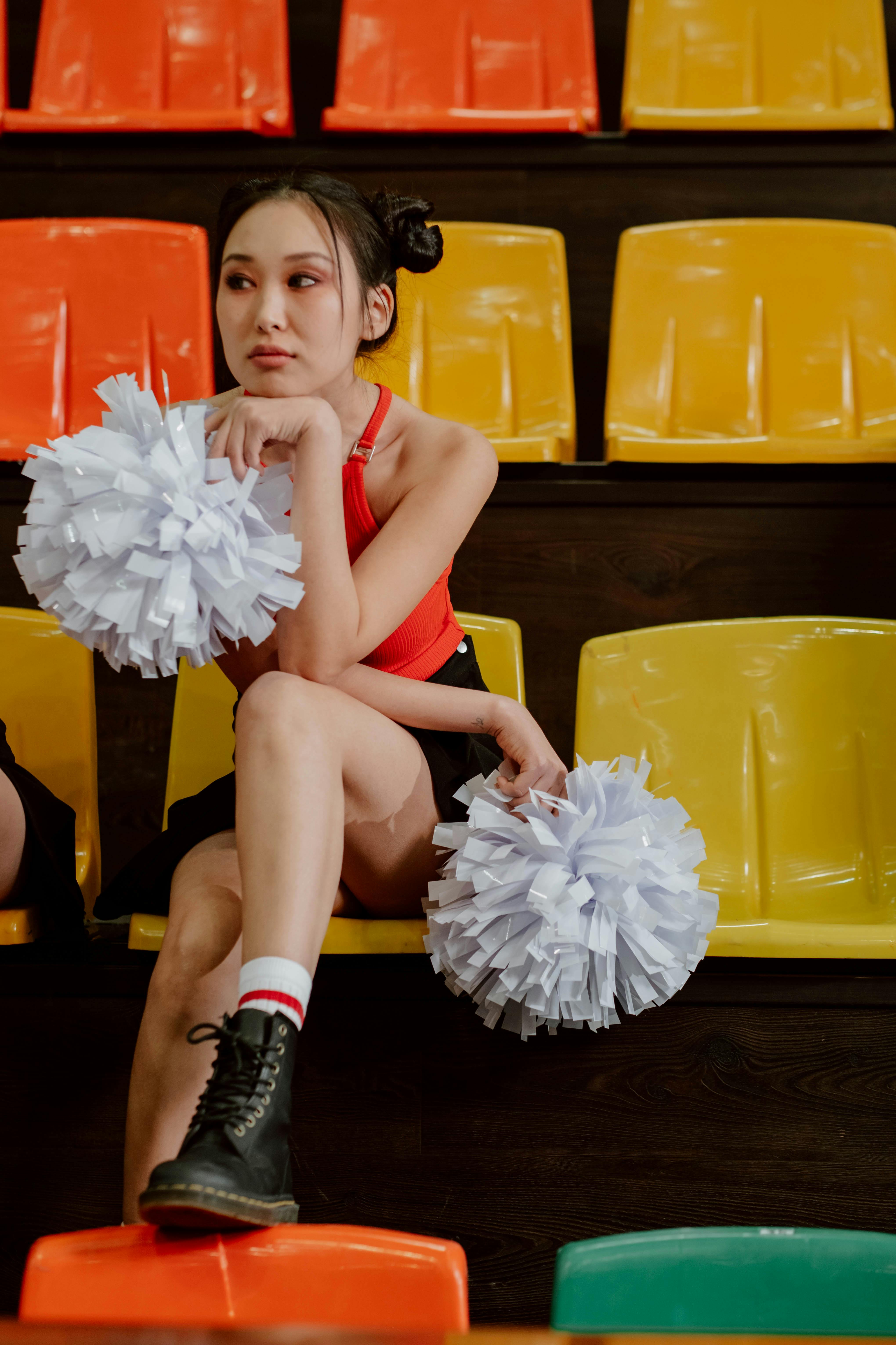 A Group of Cheerleaders Holding Pompoms Sitting on Chairs · Free Stock ...