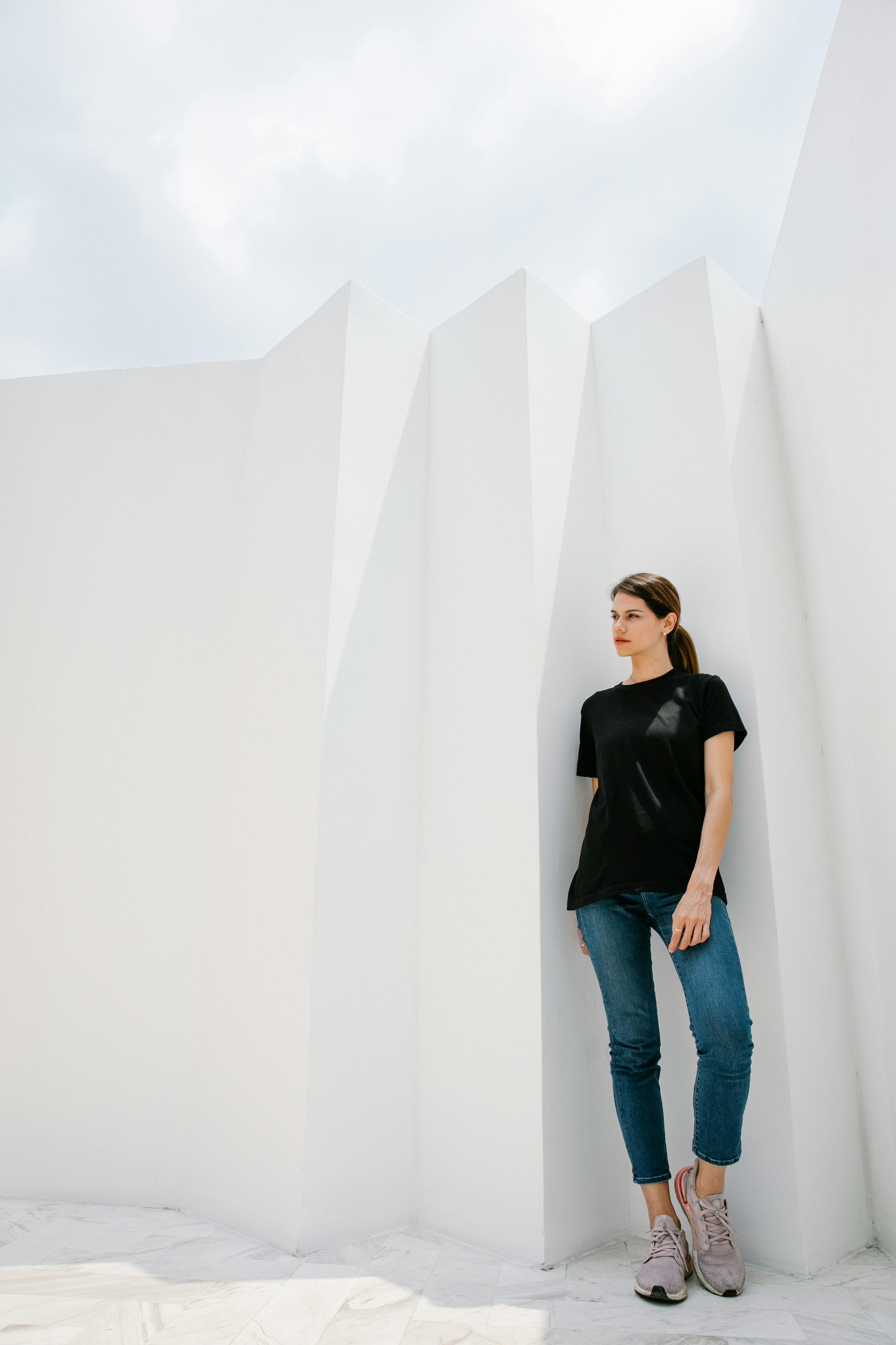 Model in casual wear on pavement in sunlight · Free Stock Photo