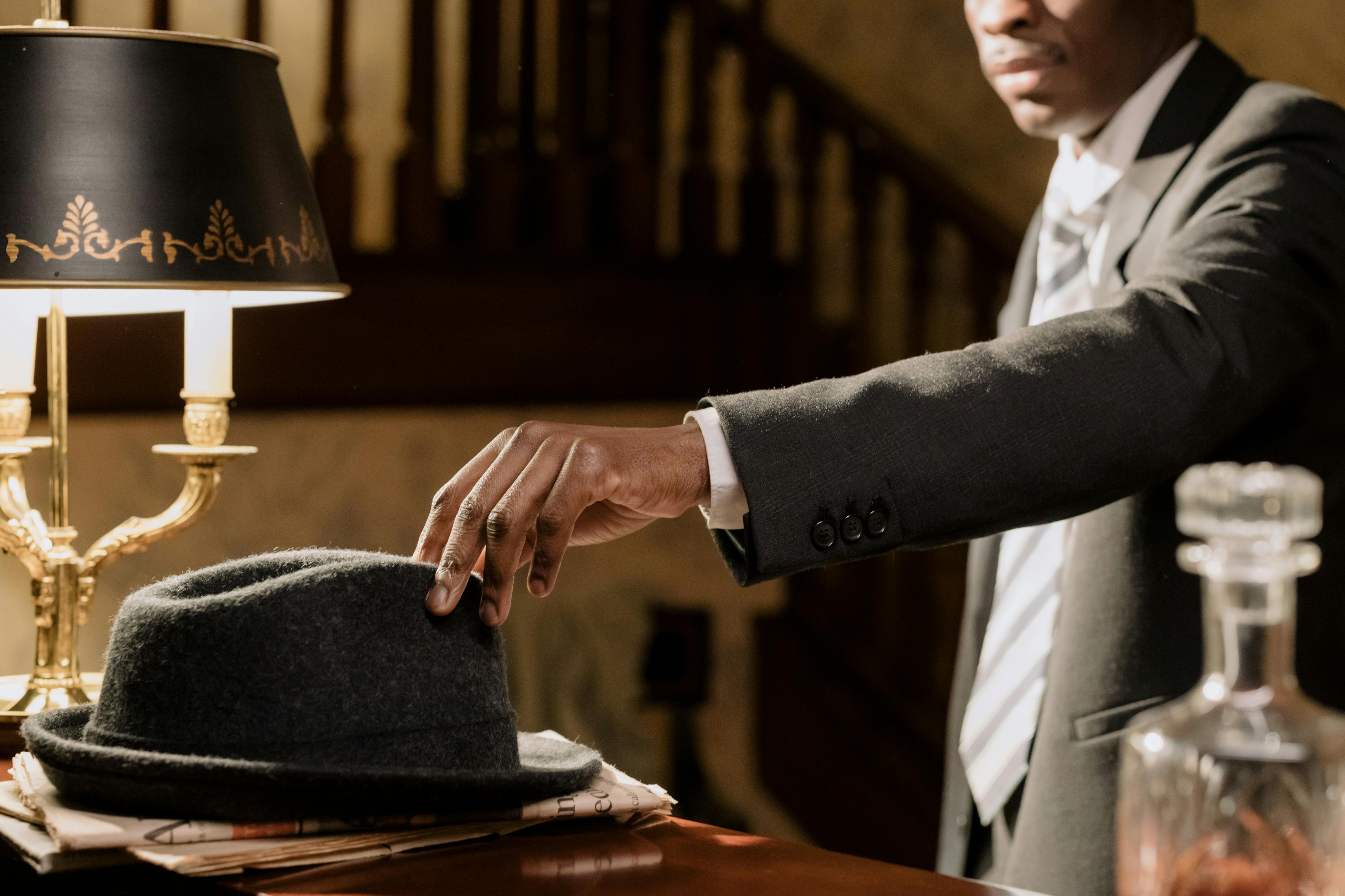 Photo of Person Holding his Fedora Hat · Free Stock Photo