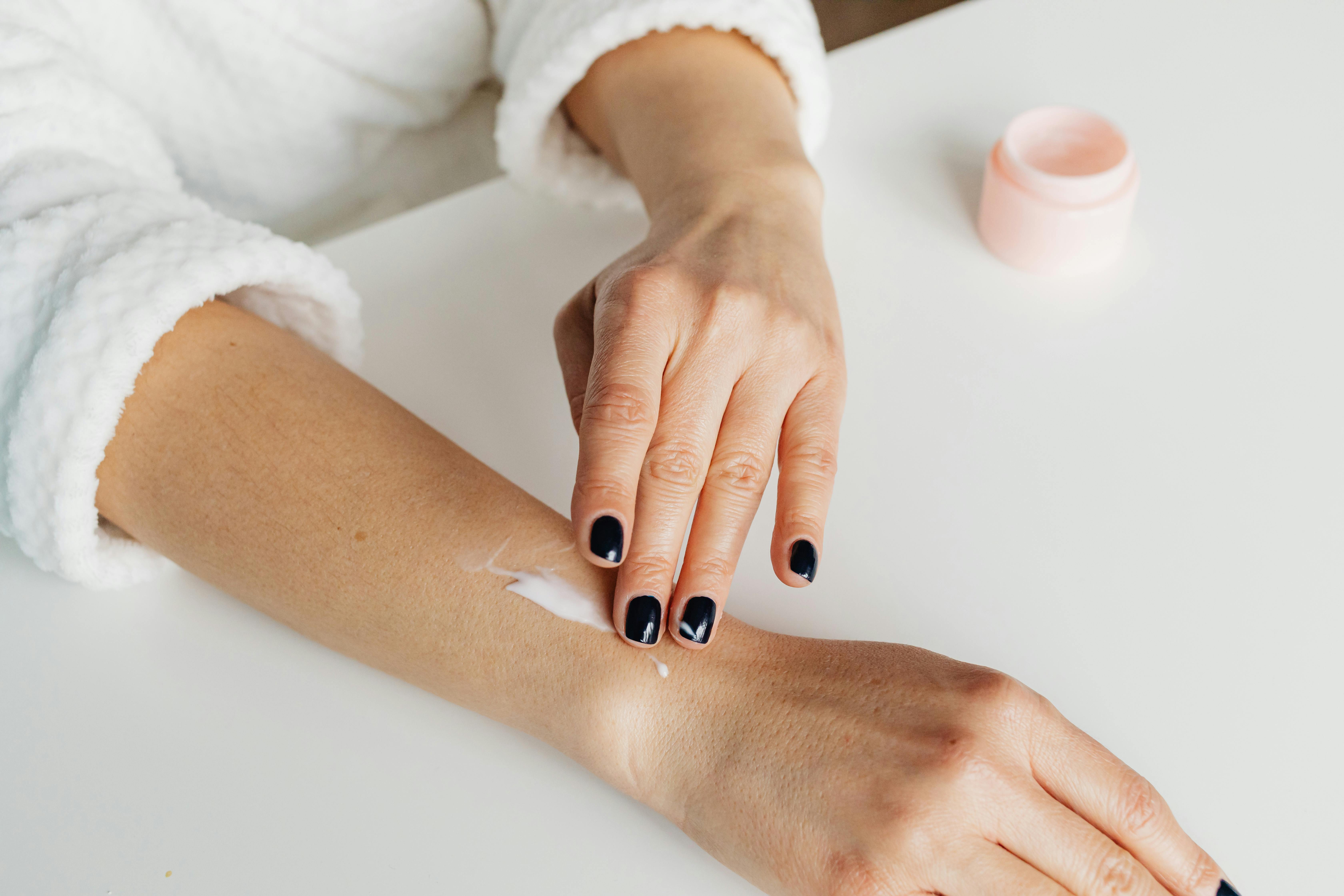 Close Up Photo of Person Applying Cream on Skin · Free Stock Photo