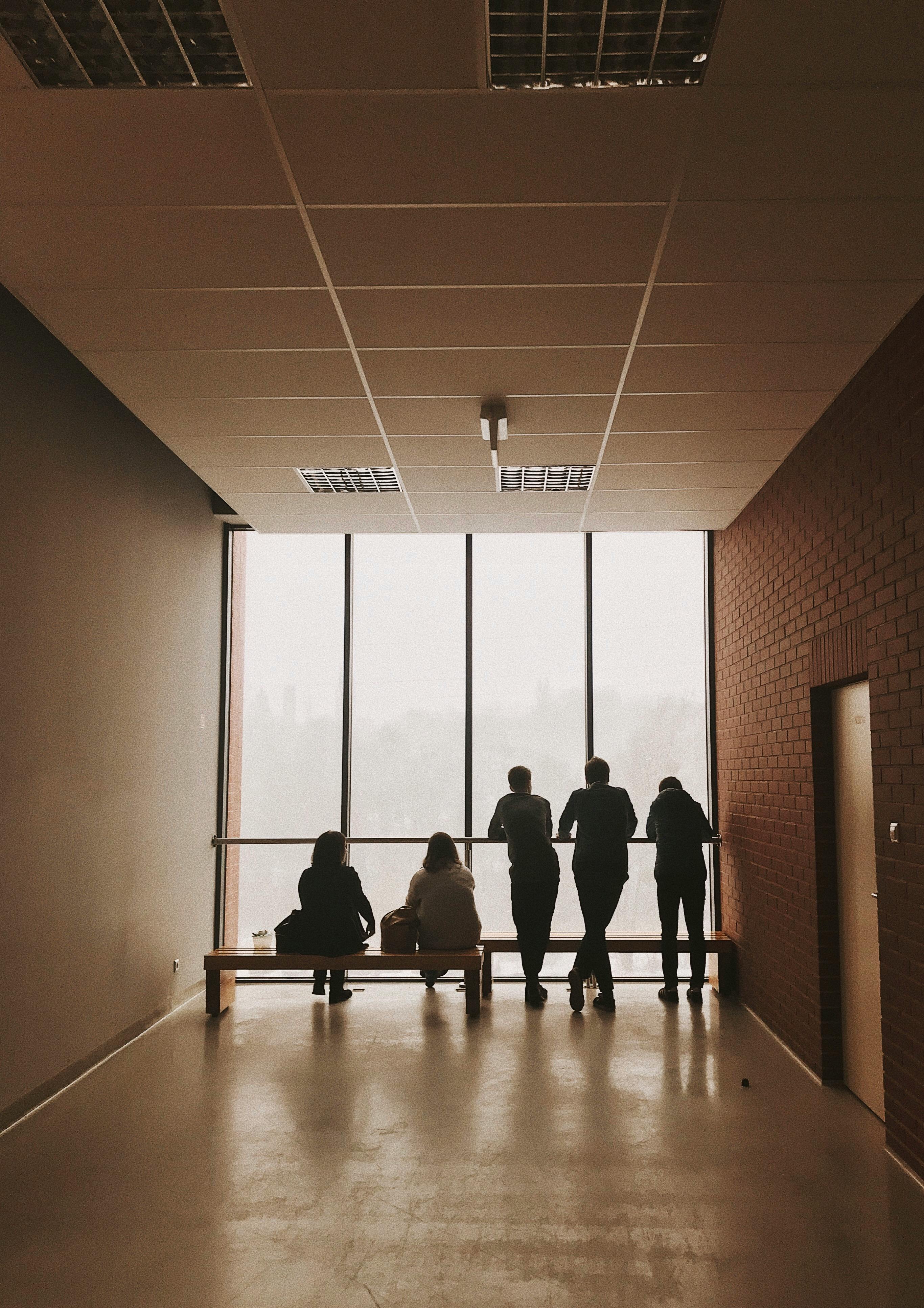 People Standing by a Window · Free Stock Photo