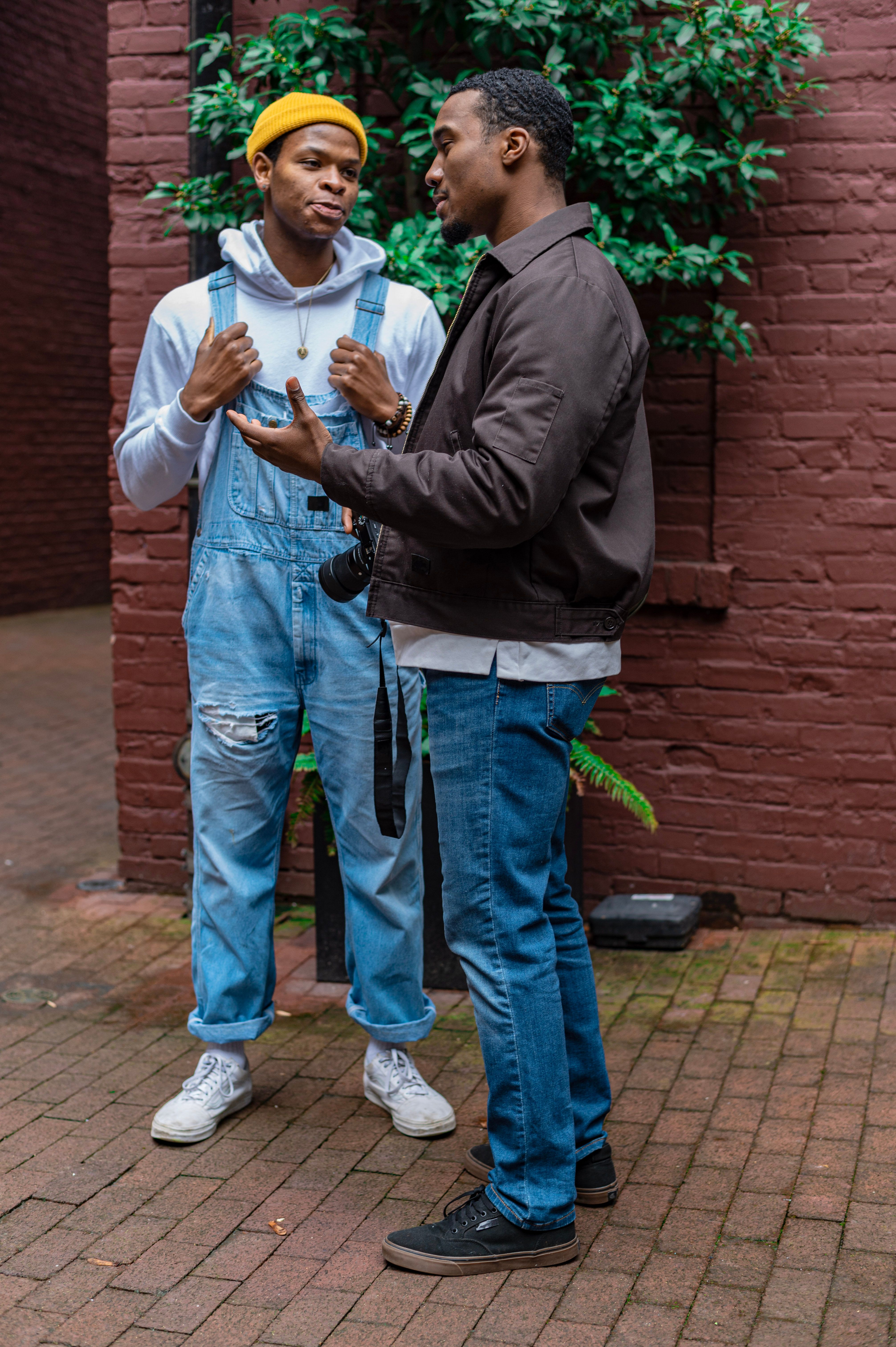 Two Men Standing Outdoors and Talking · Free Stock Photo