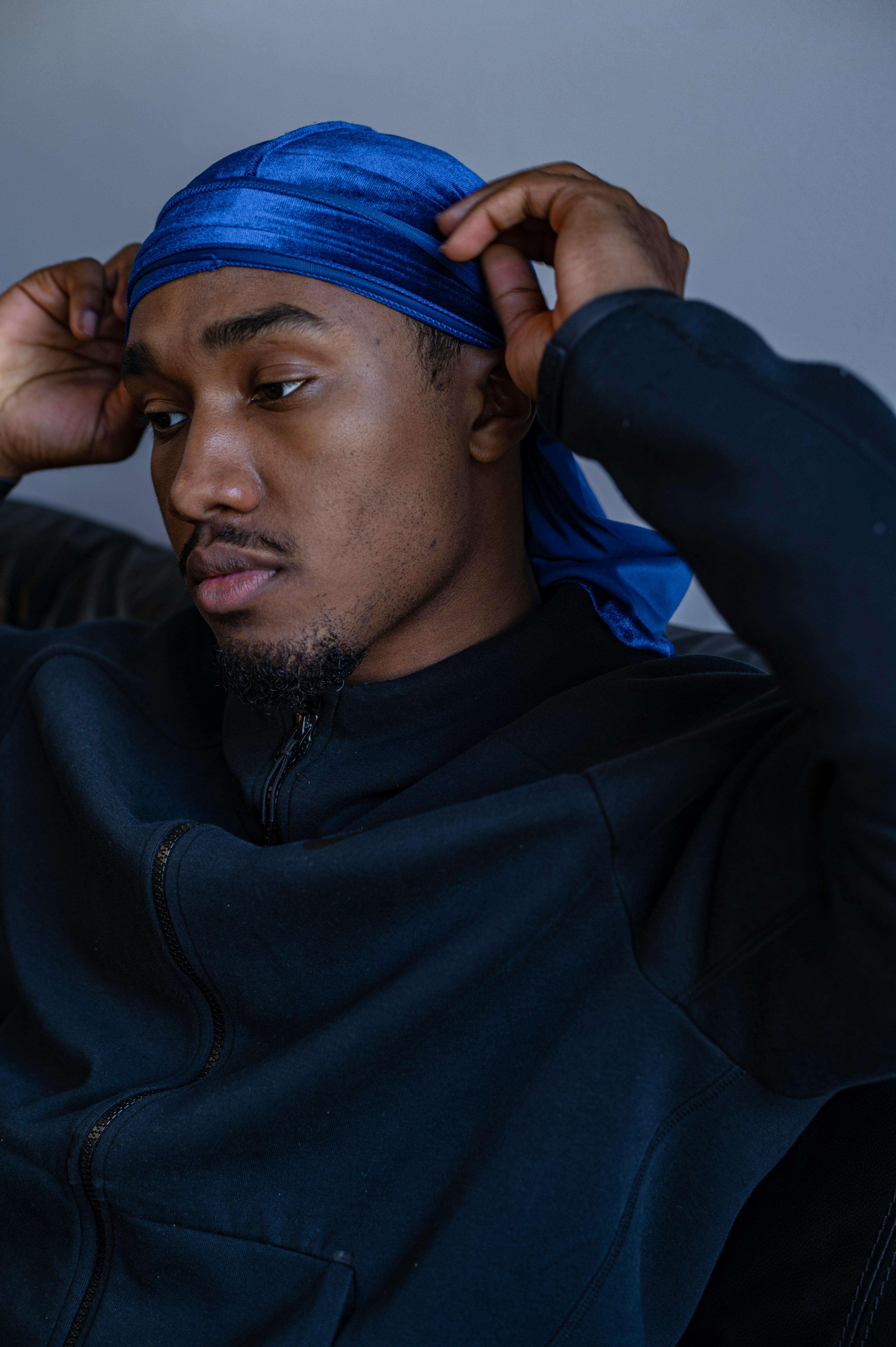 A Man in Black Jacket Wearing Blue Cap · Free Stock Photo