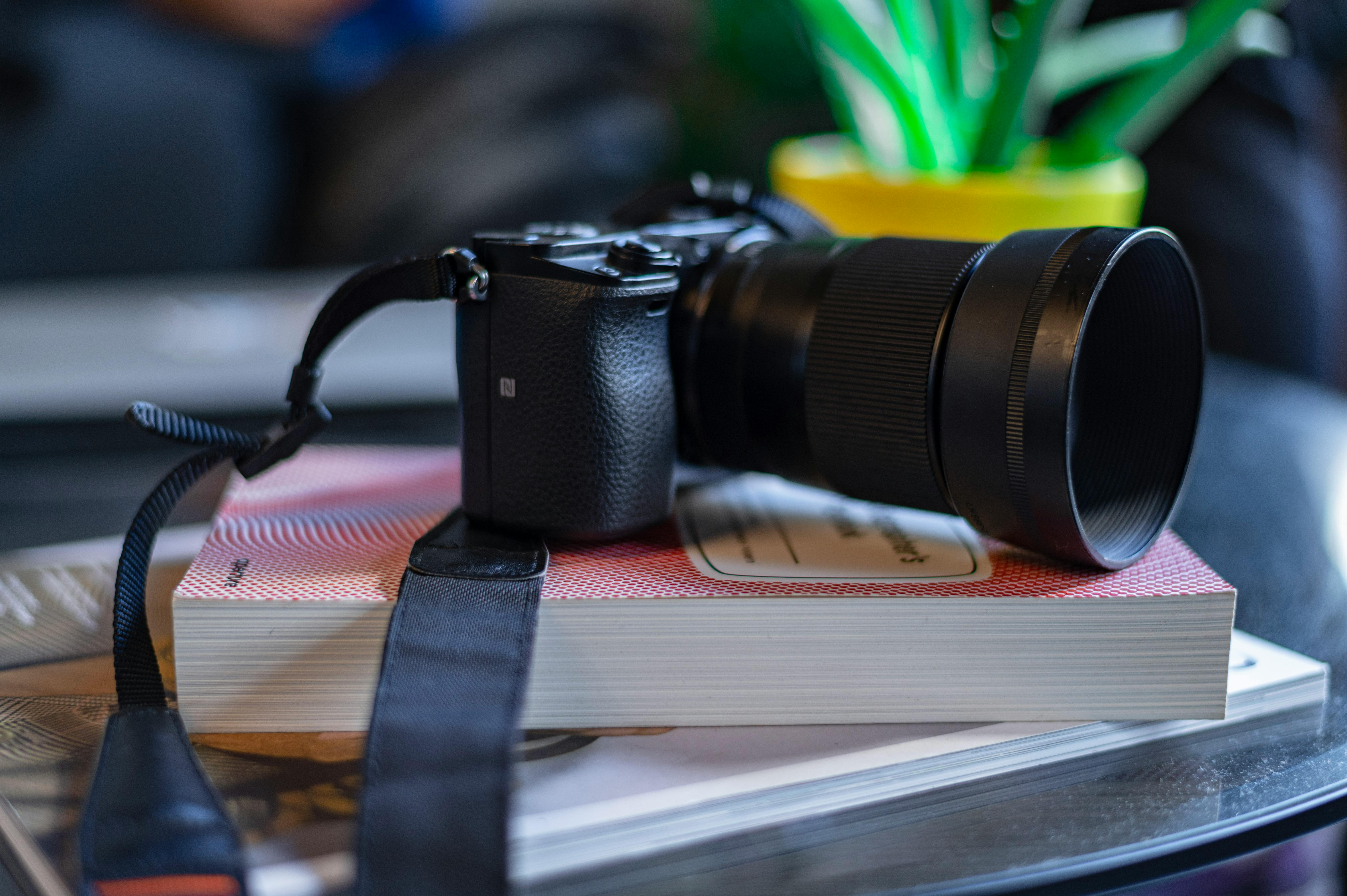 Black Dslr Camera on Top of Book · Free Stock Photo