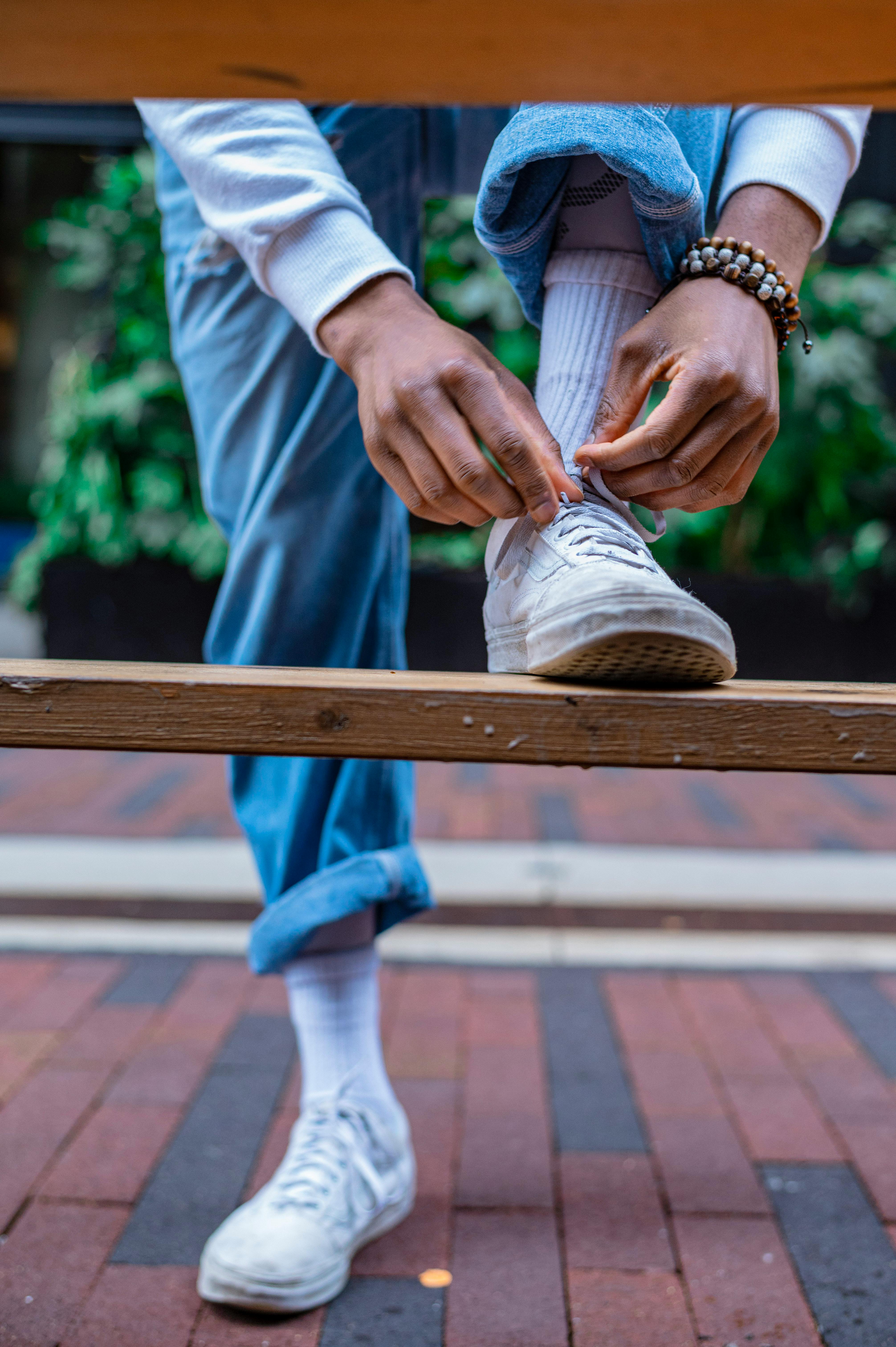 A Person Tying their Shoes · Free Stock Photo