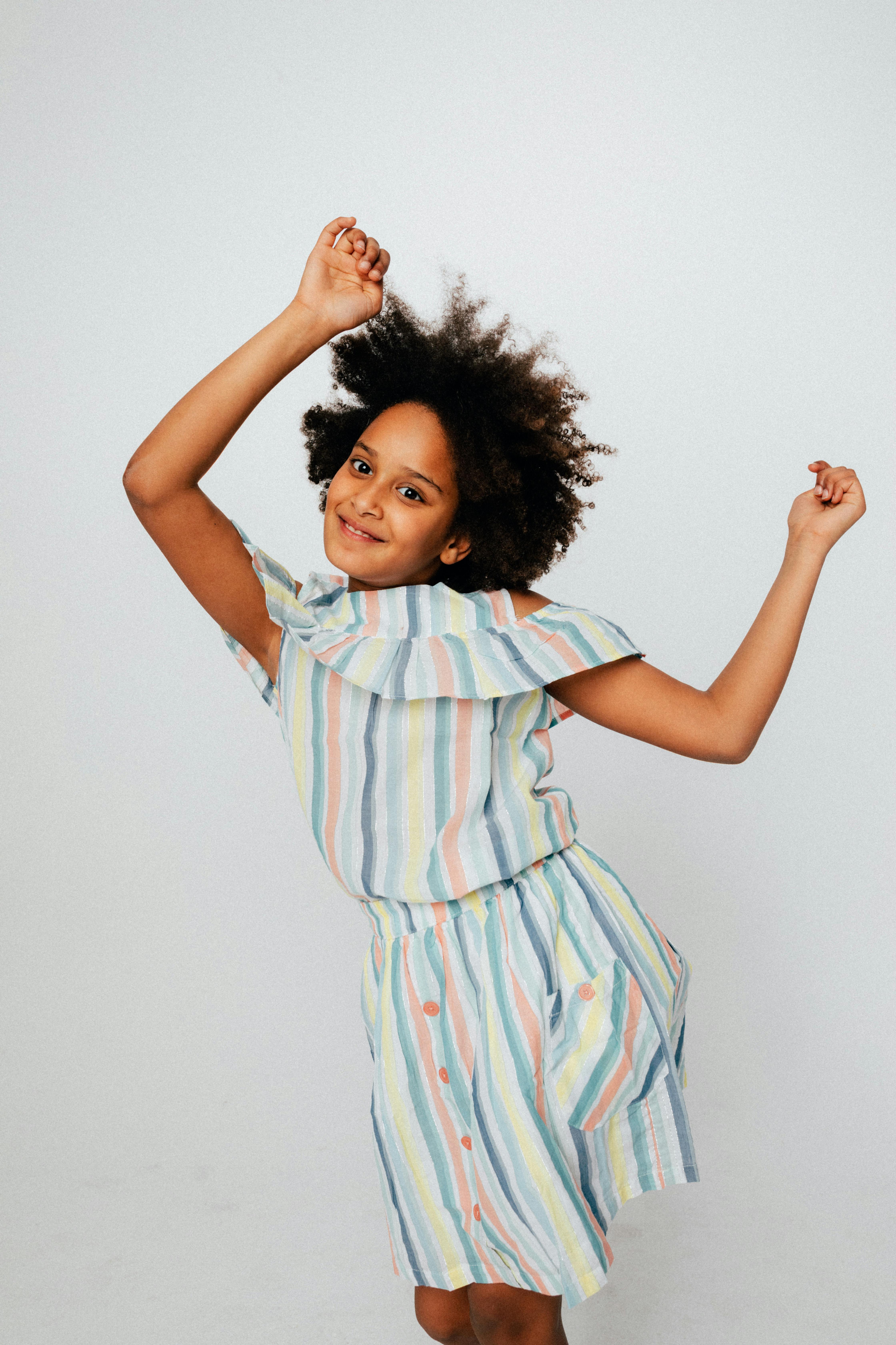 Girl in Stripe Dress Dancing · Free Stock Photo