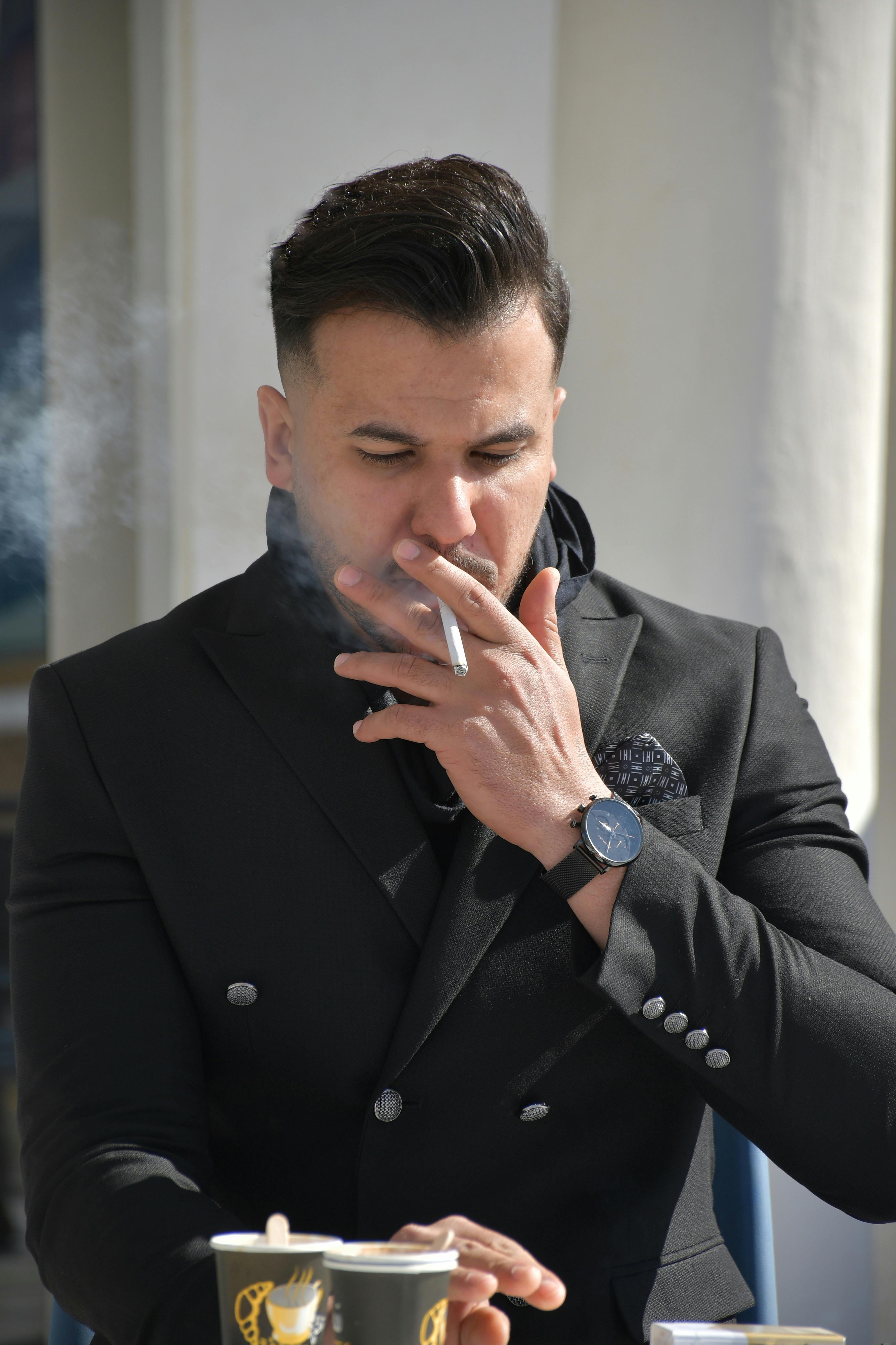Man in Black Suit Jacket Smoking Cigarette · Free Stock Photo
