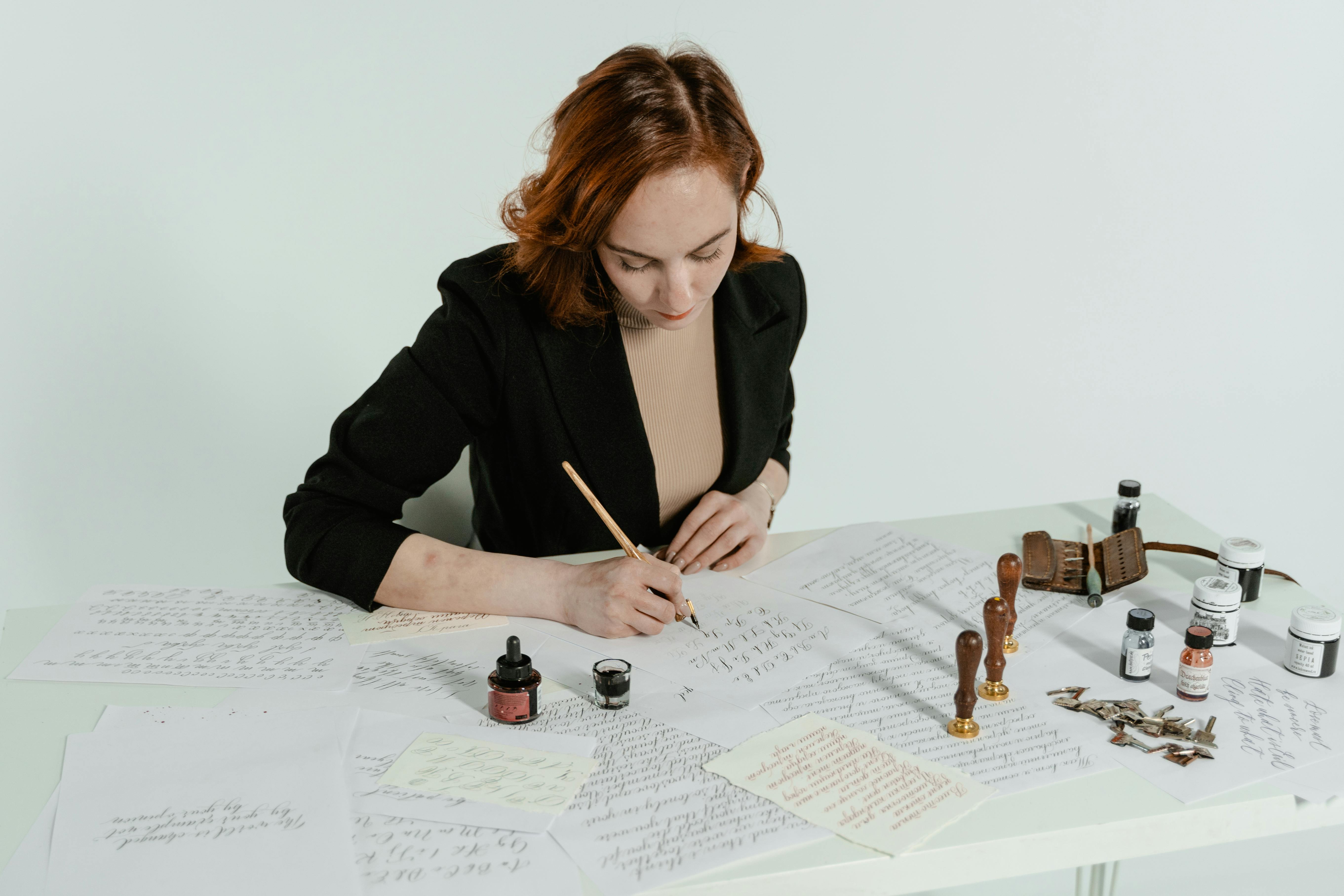 Woman in Black Blazer Writing on White Paper · Free Stock Photo