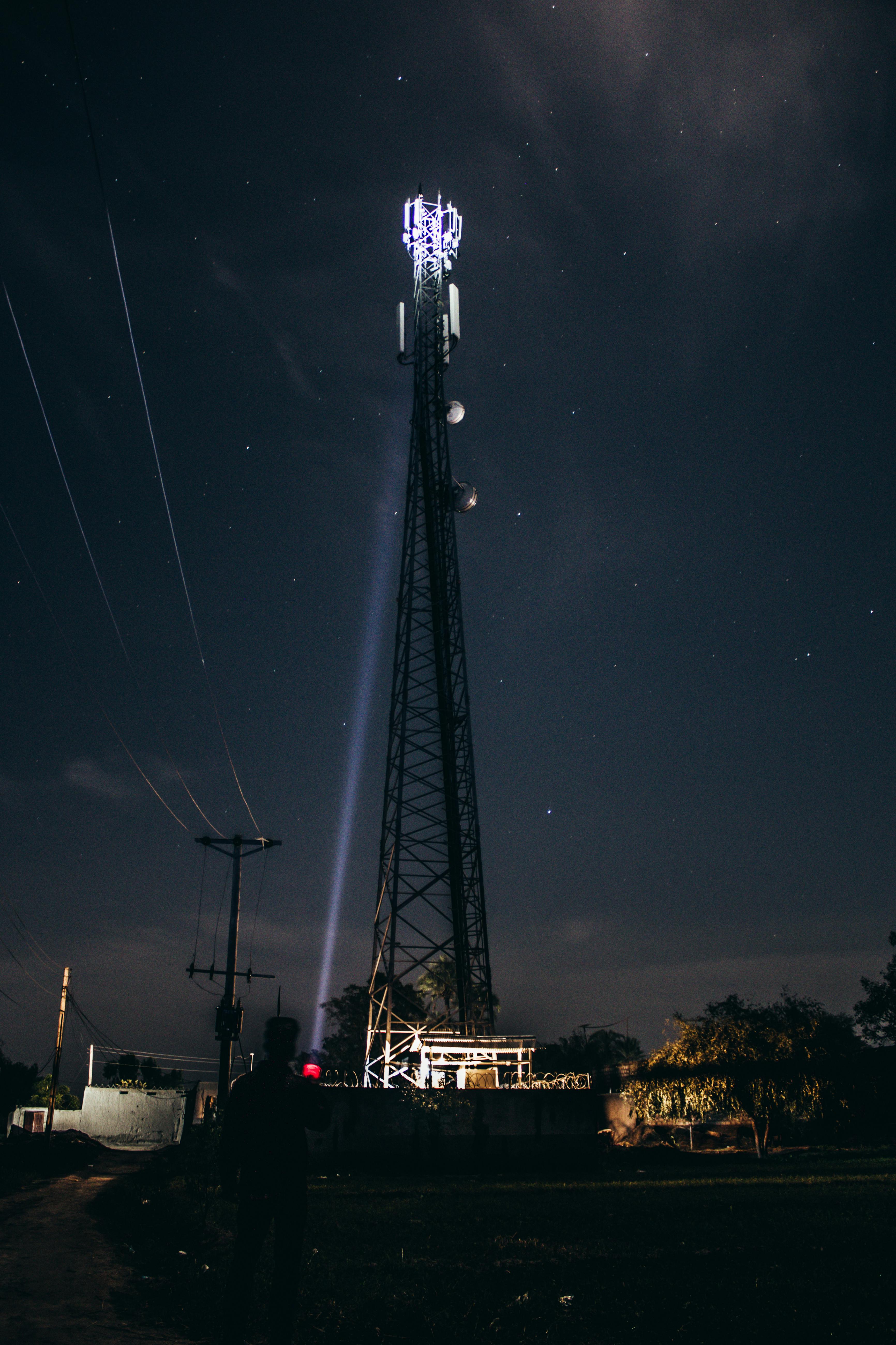 A Tower with Light under a Night Sky with Stars · Free Stock Photo