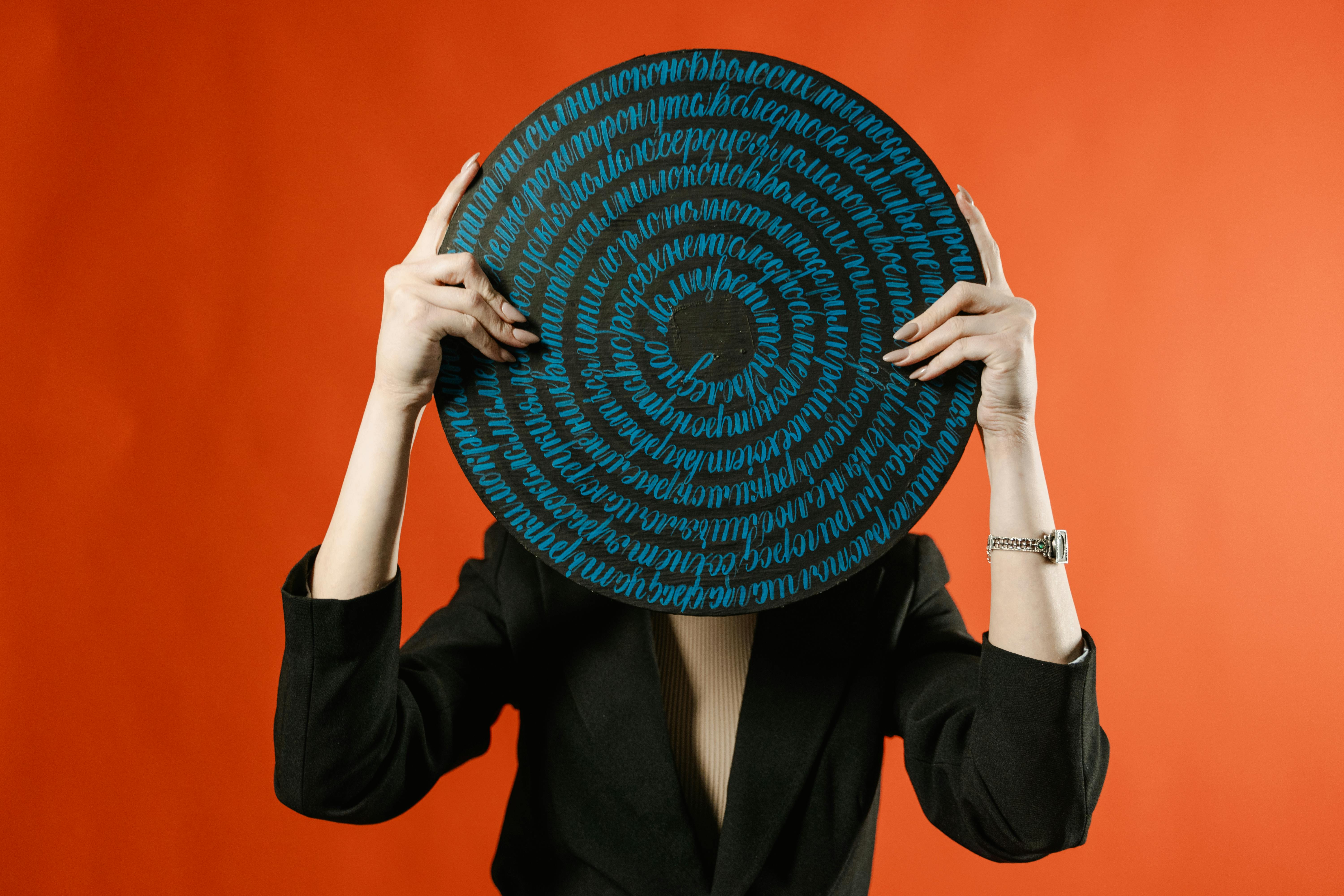 Person with Face Covered of a Board with Handwriting · Free Stock Photo