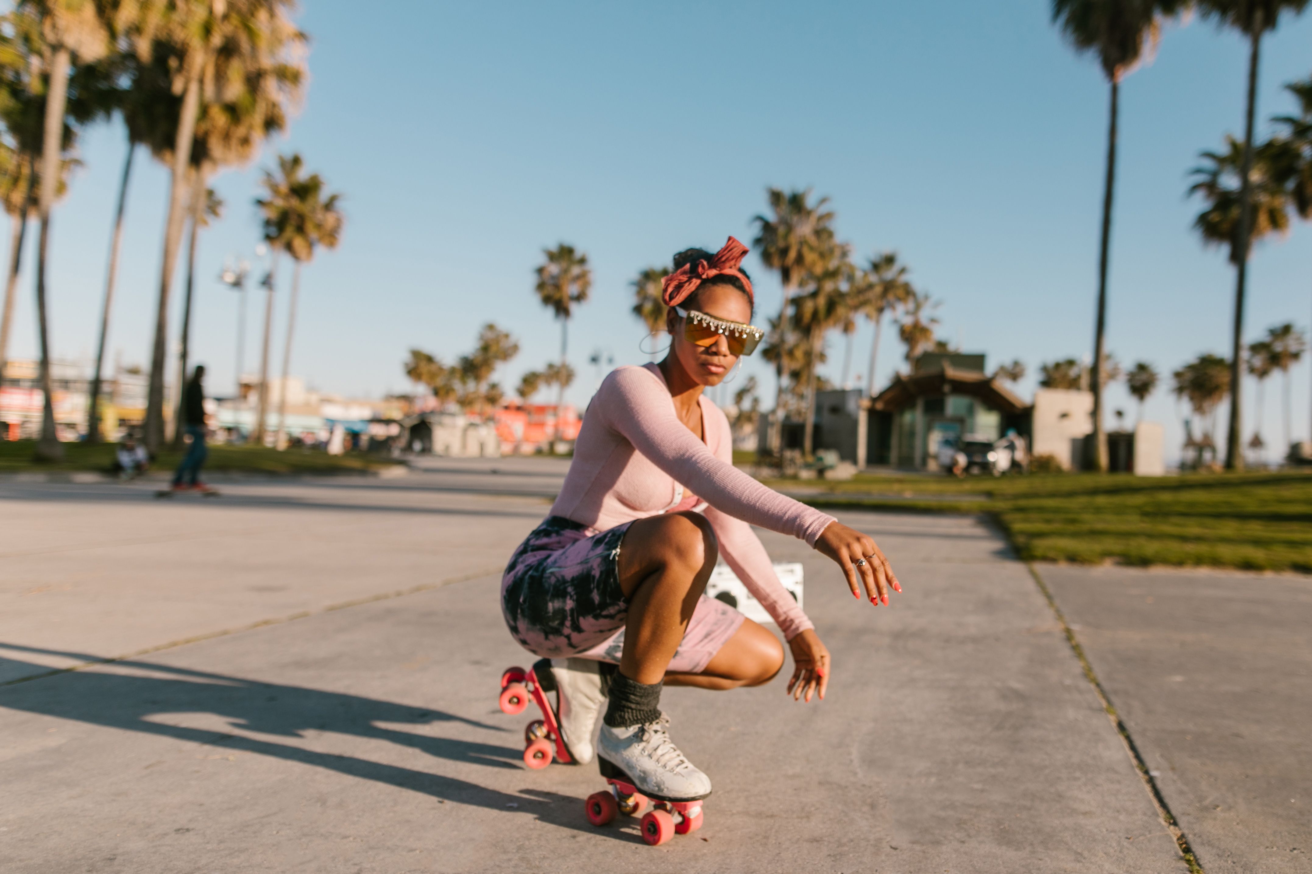 A Man with Sunglasses Roller Skating Near a Boombox · Free Stock Photo