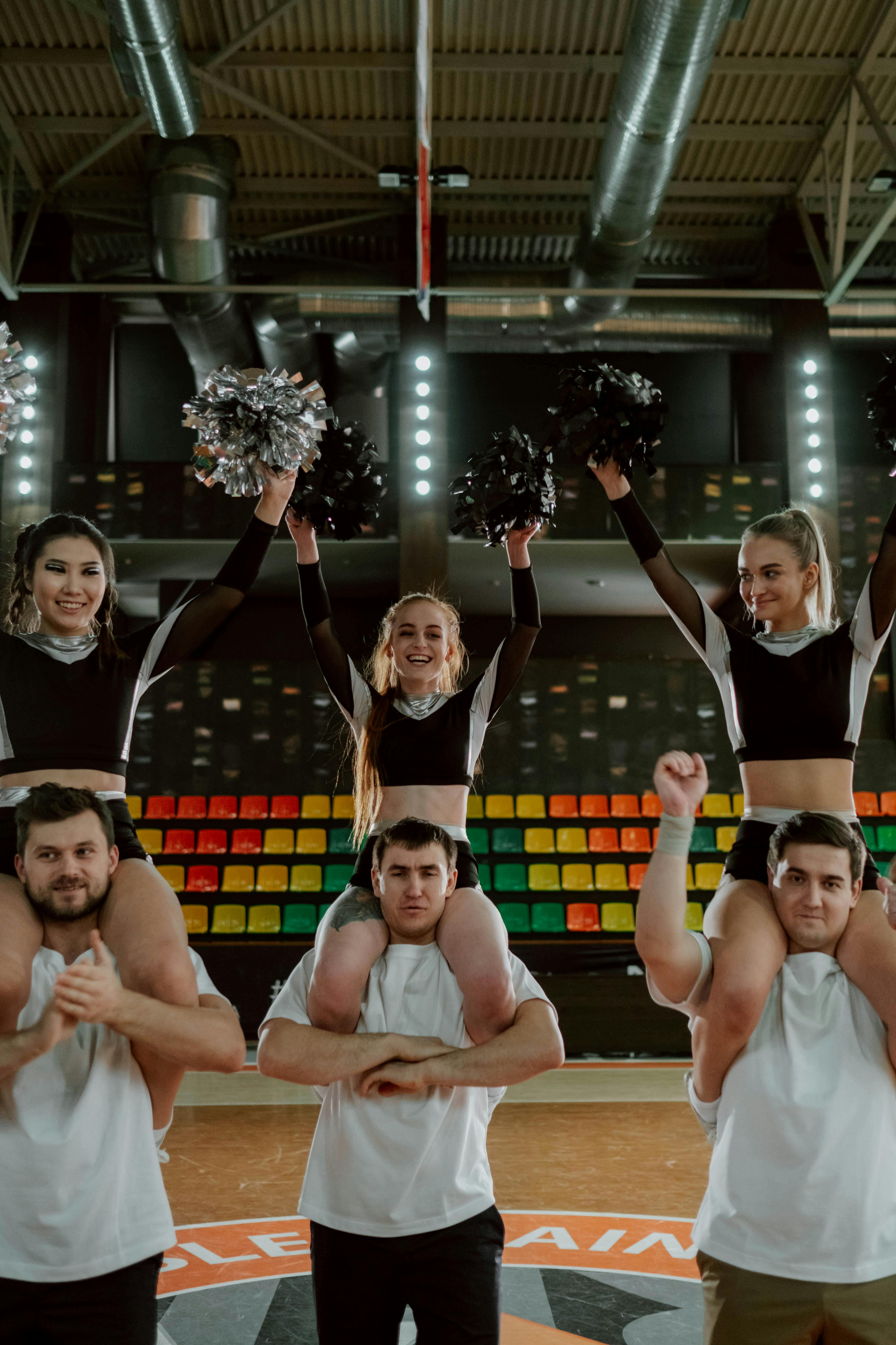 Cheerleaders Sitting on Men Shoulders · Free Stock Photo
