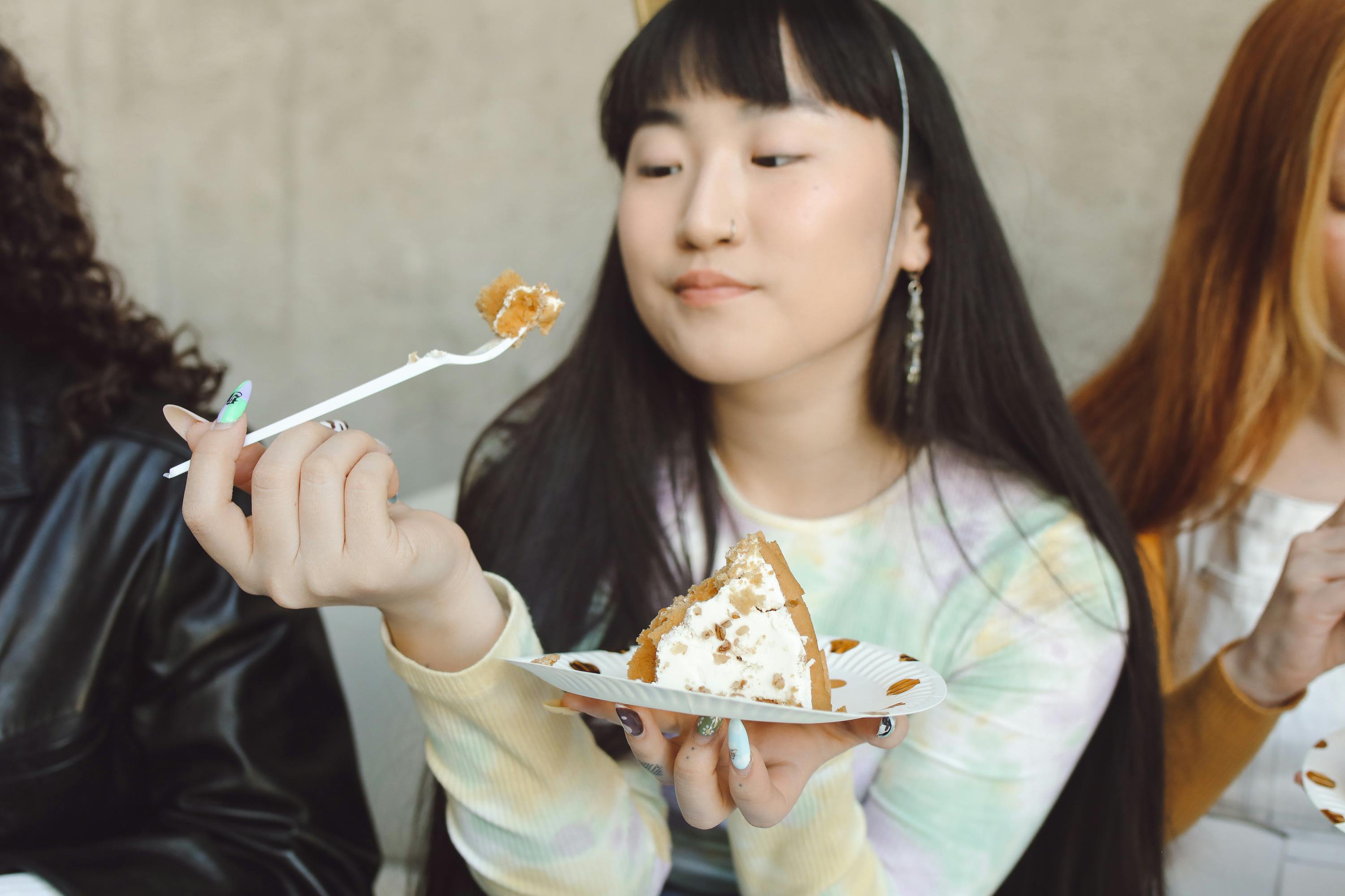 Woman Eating Snacks at Table · Free Stock Photo