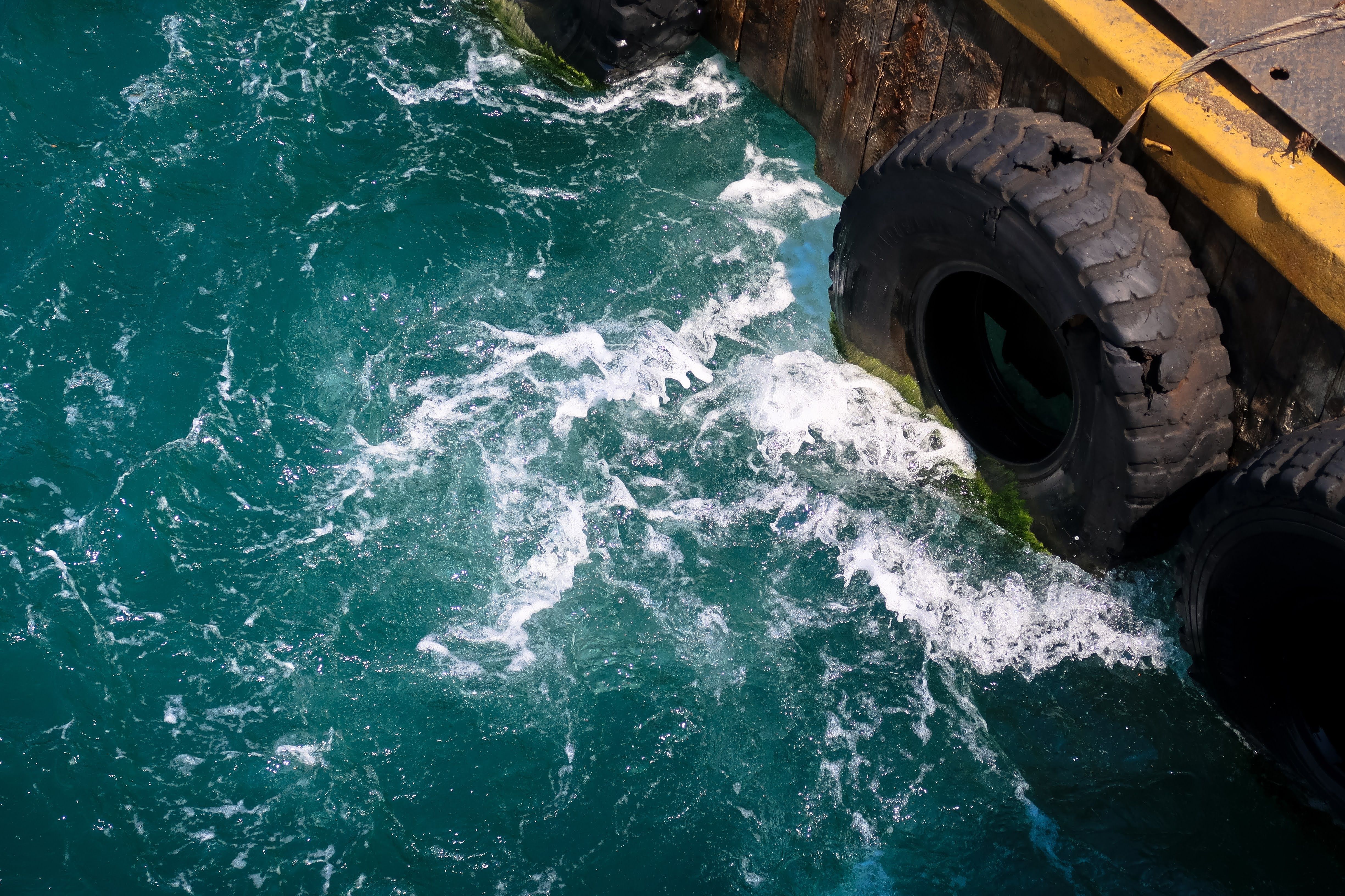 Waves crashing on a Tire · Free Stock Photo
