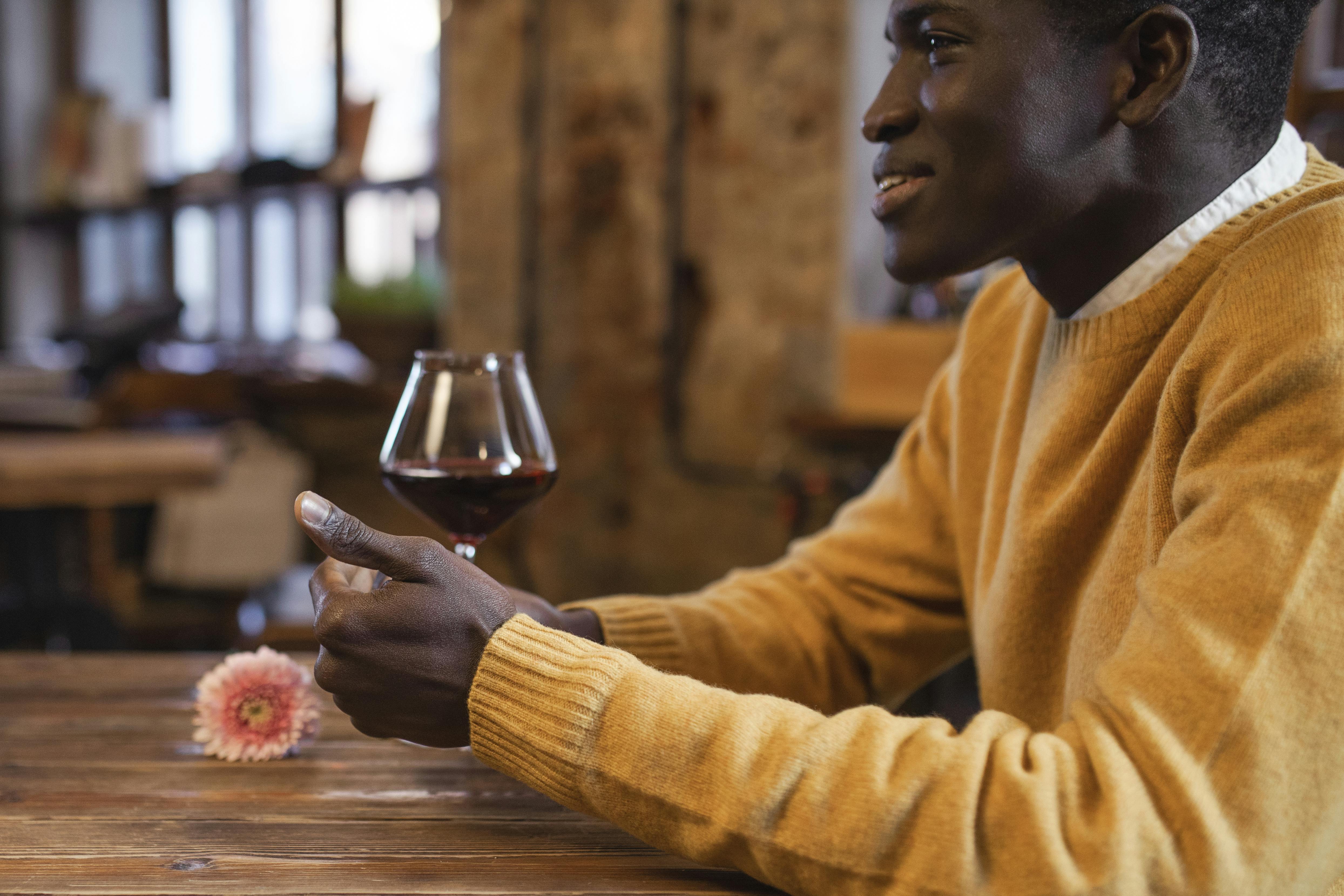 Man Sitting at a Table and Drinking Red Wine · Free Stock Photo