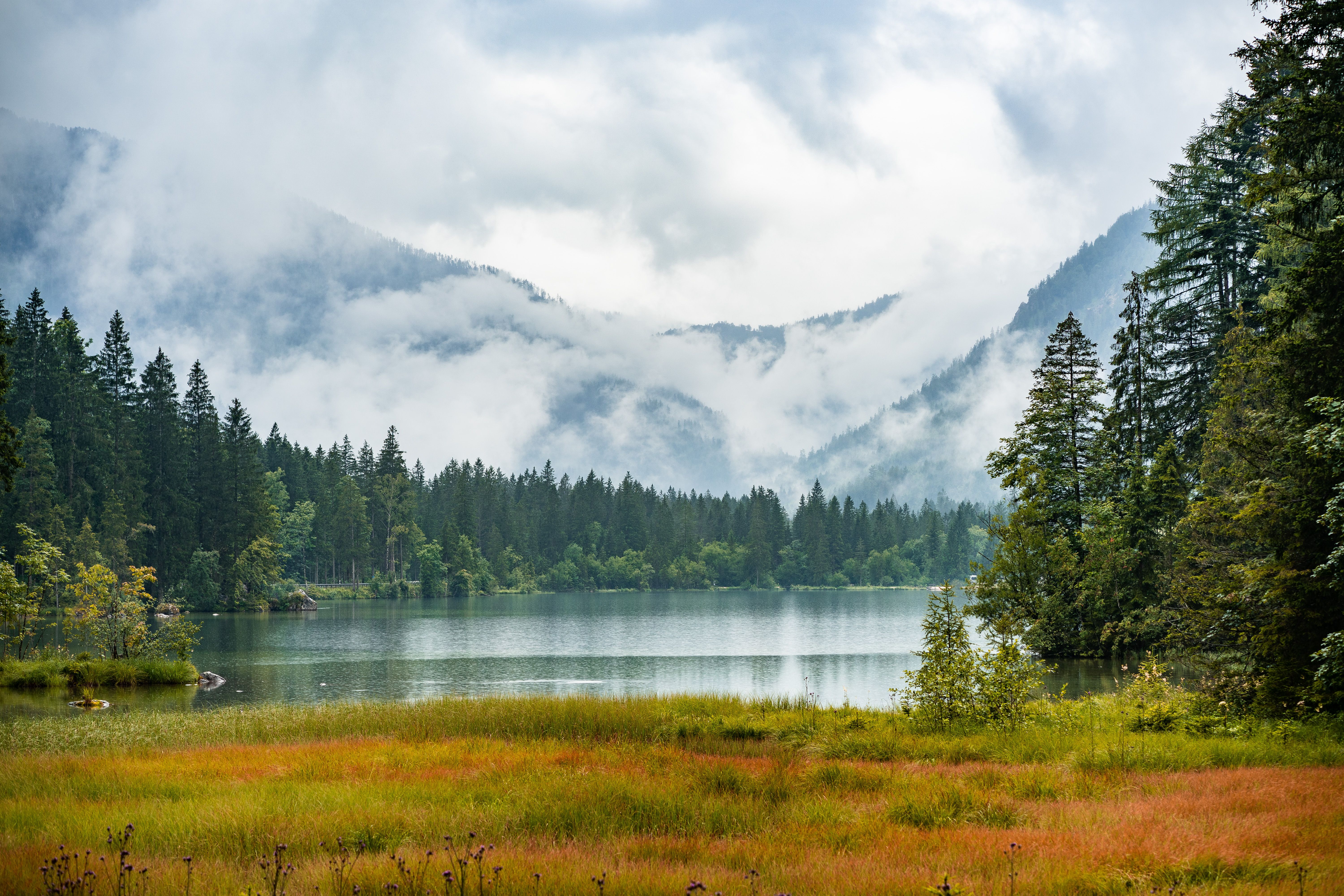 Calm Body of Water Near Mountain · Free Stock Photo