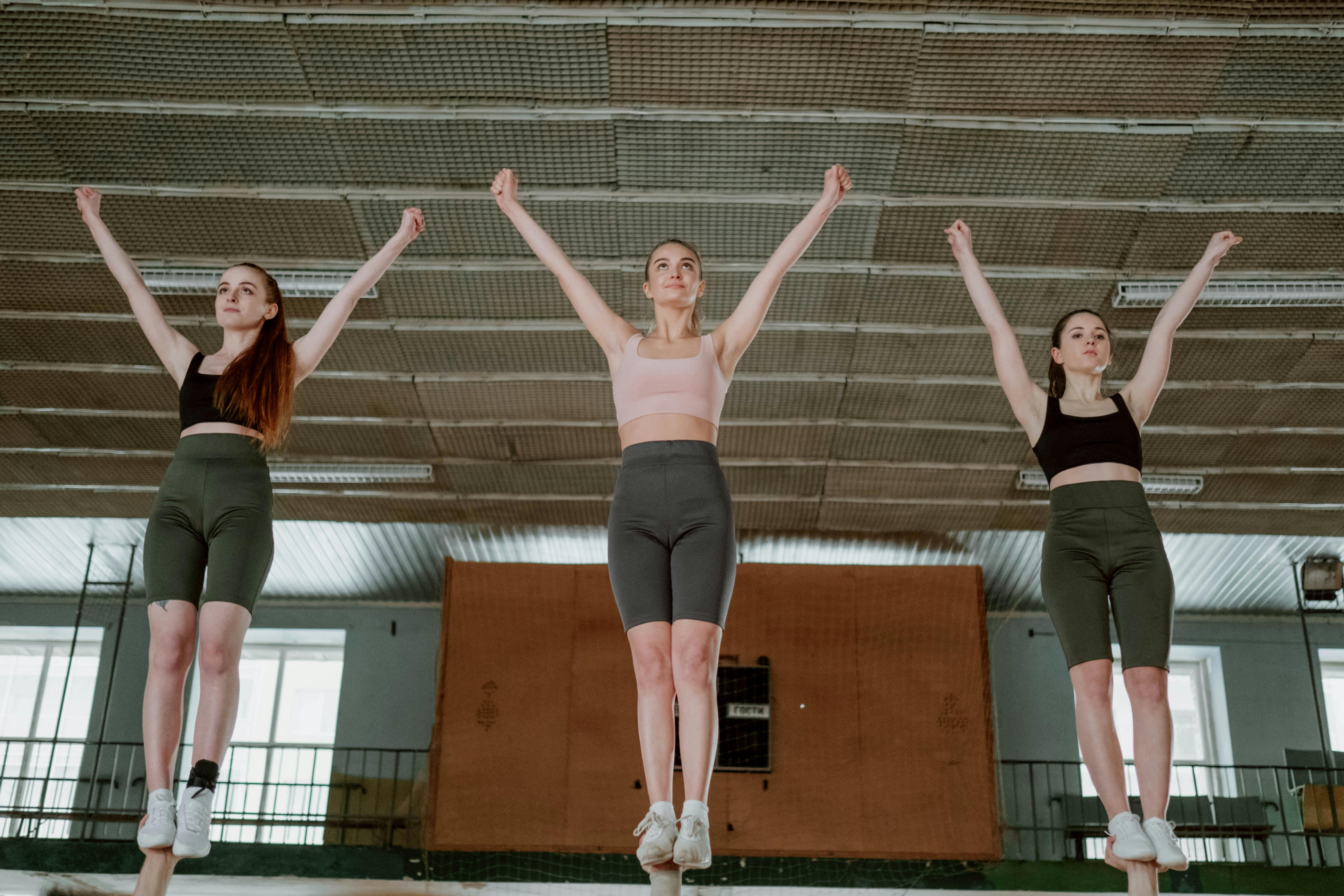 Low Angle Shot of Female Cheerleaders · Free Stock Photo
