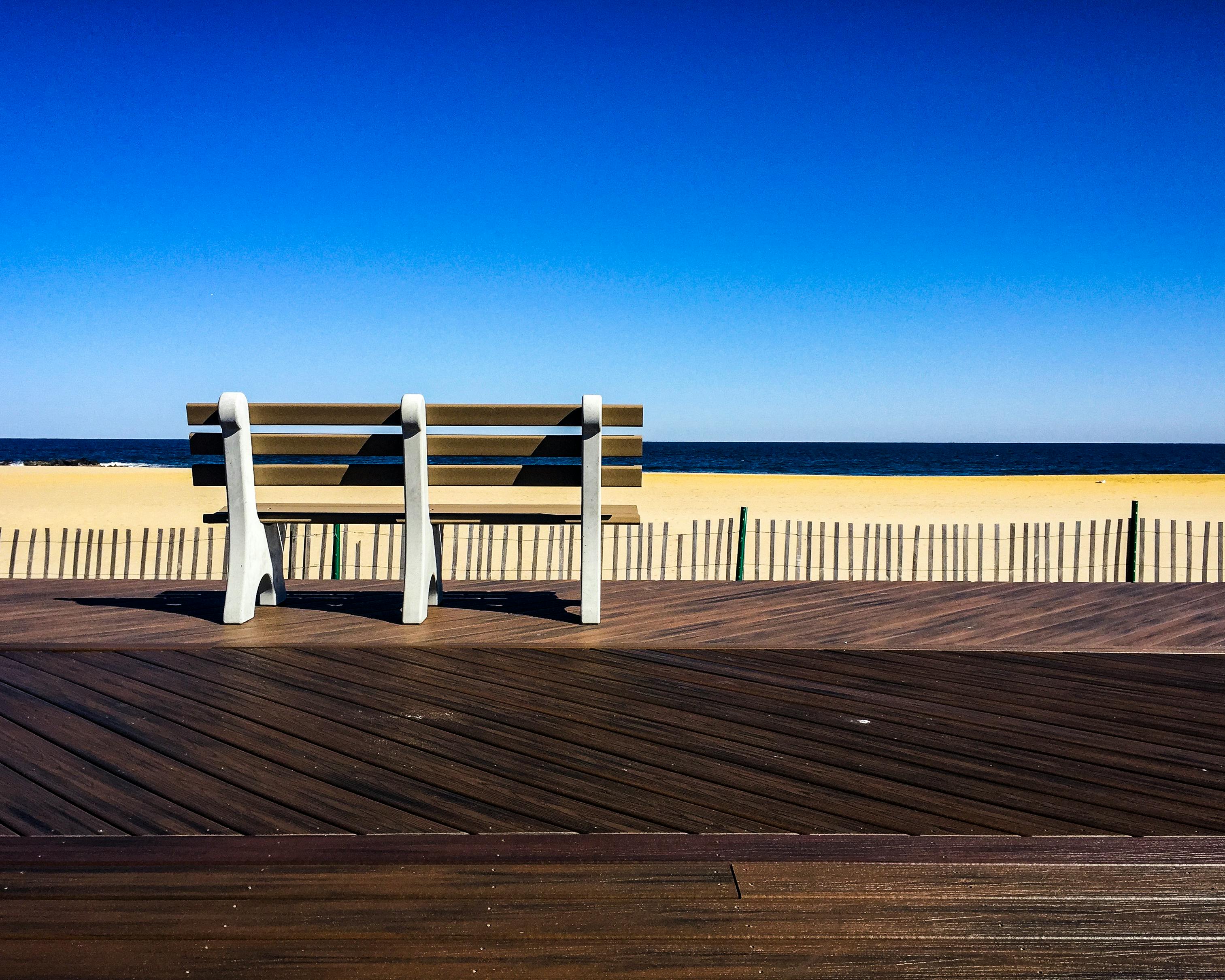 Brown-and-white Wooden Bench Facing Body of Water Under Clear Blue Sky ...