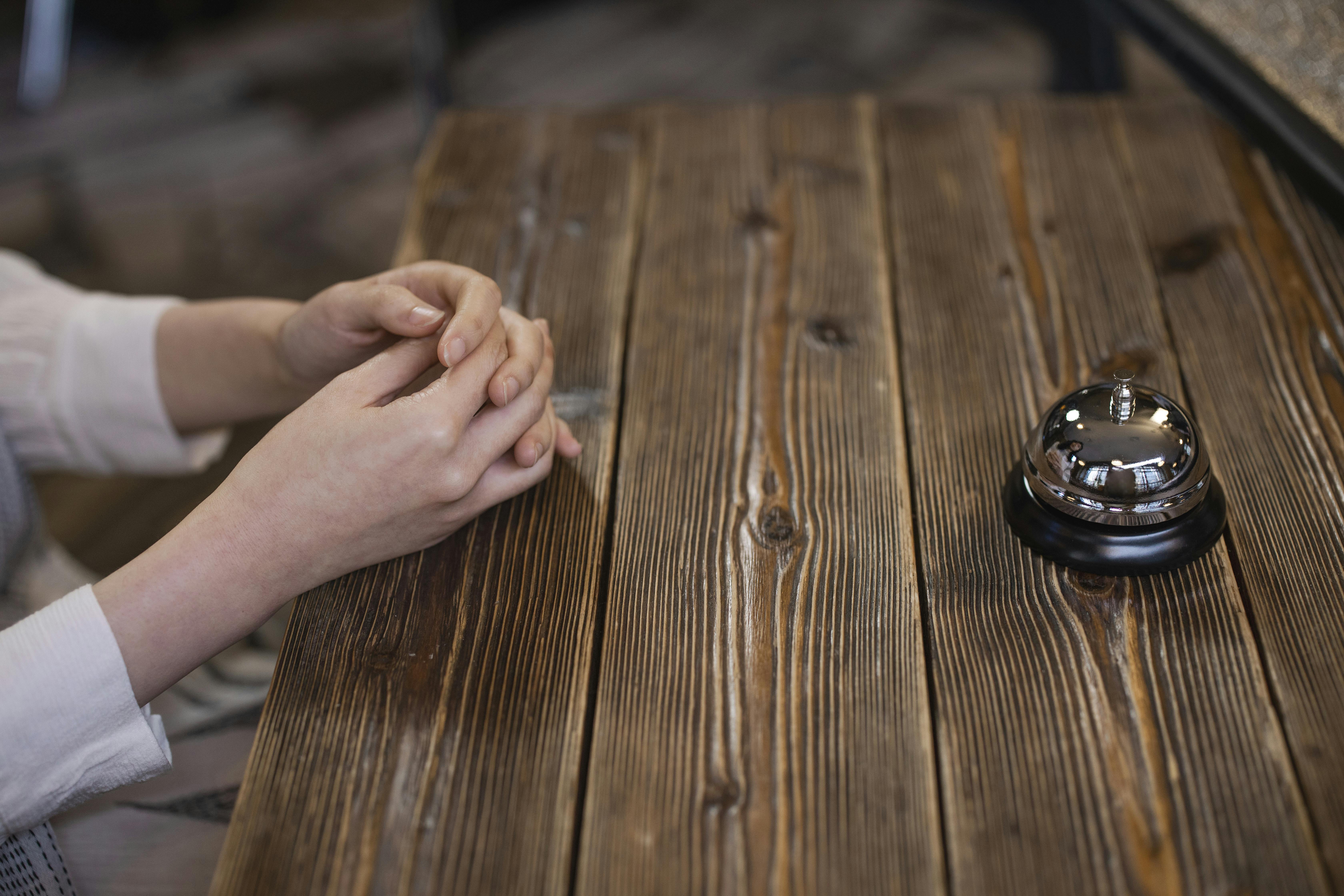 Close-Up of Gold Bell on Desk · Free Stock Photo