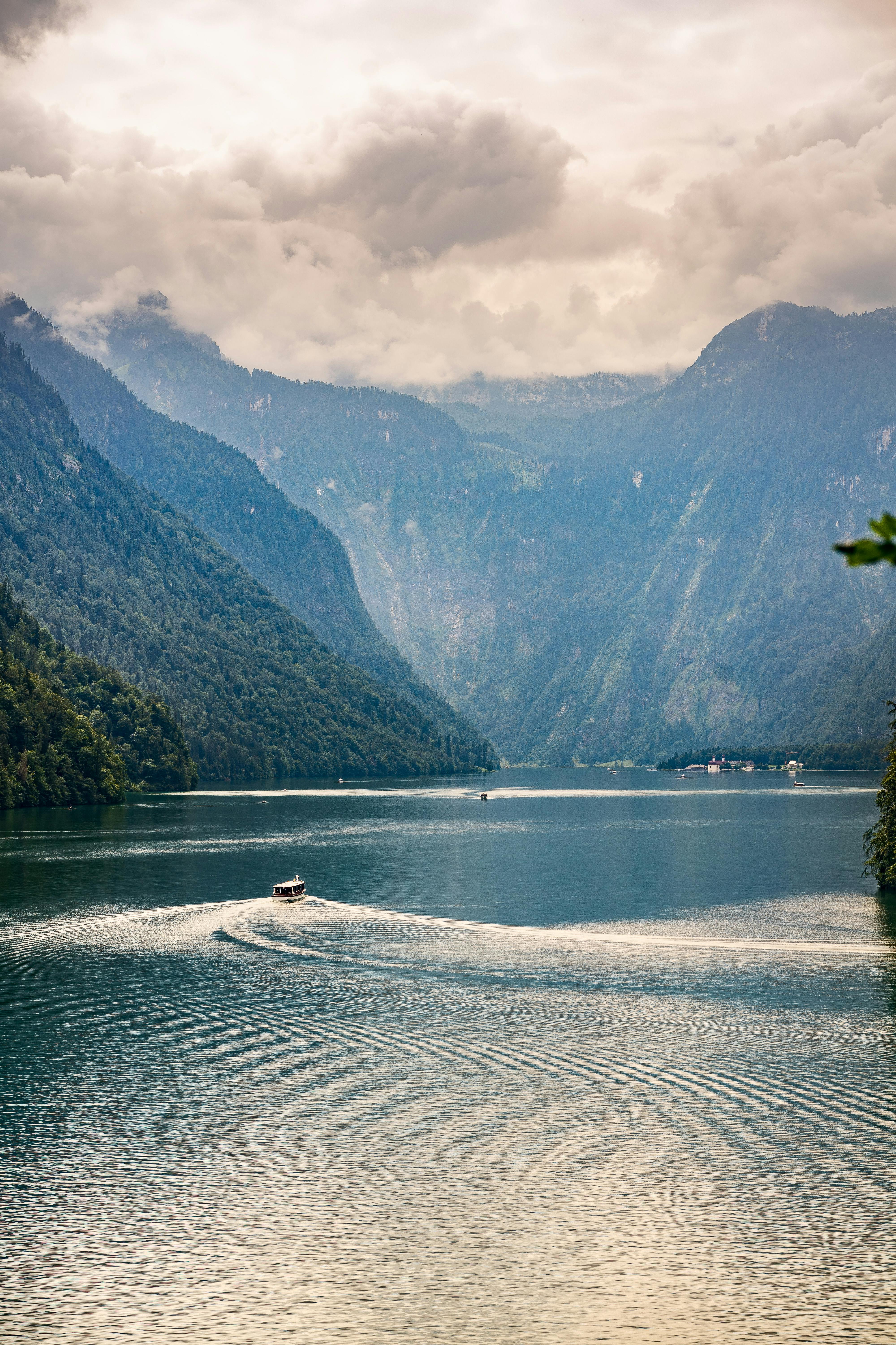 A Boat Sailing in a Mountain Lake · Free Stock Photo