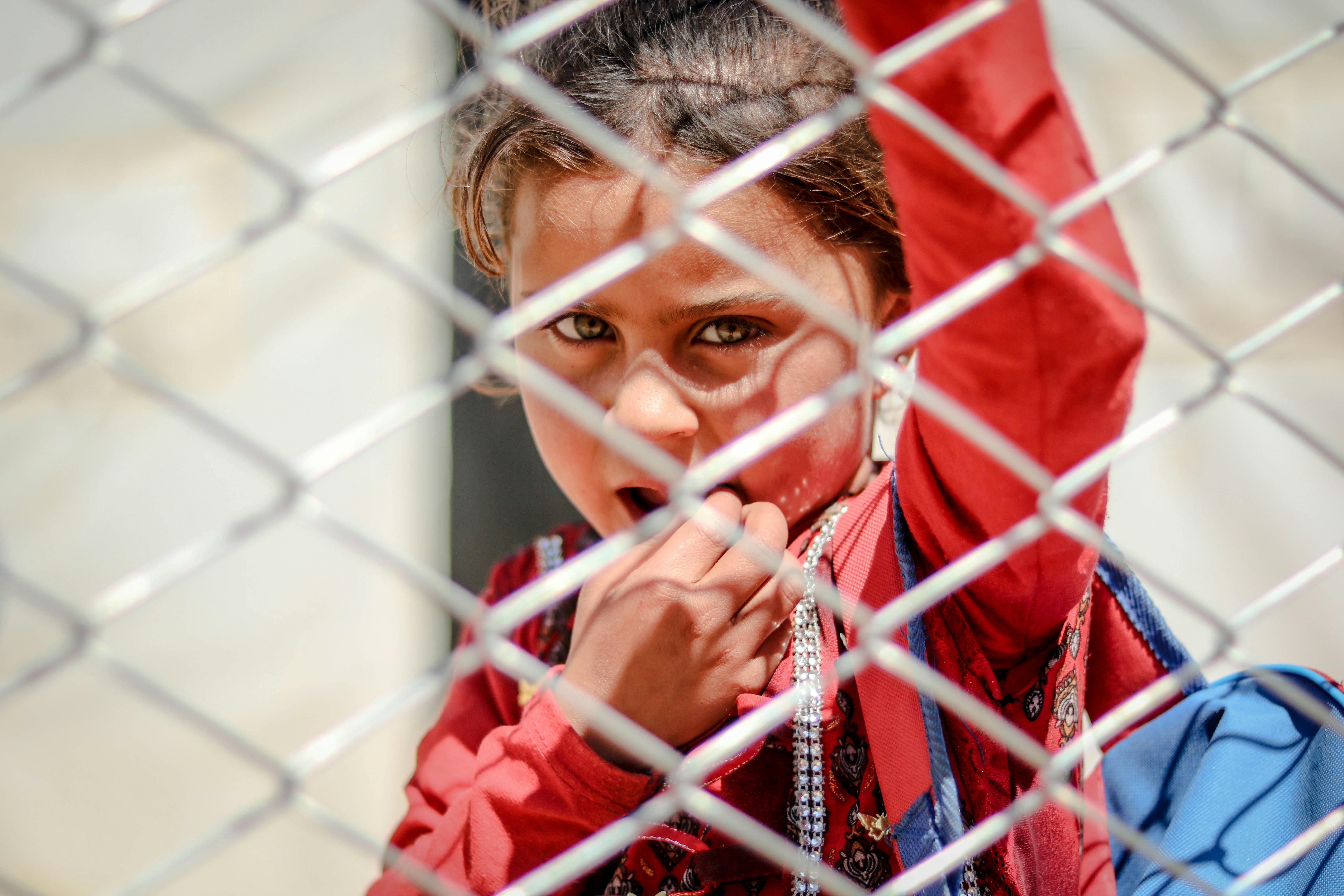 Portrait of a Young Girl Behind Fence in Idlib · Free Stock Photo