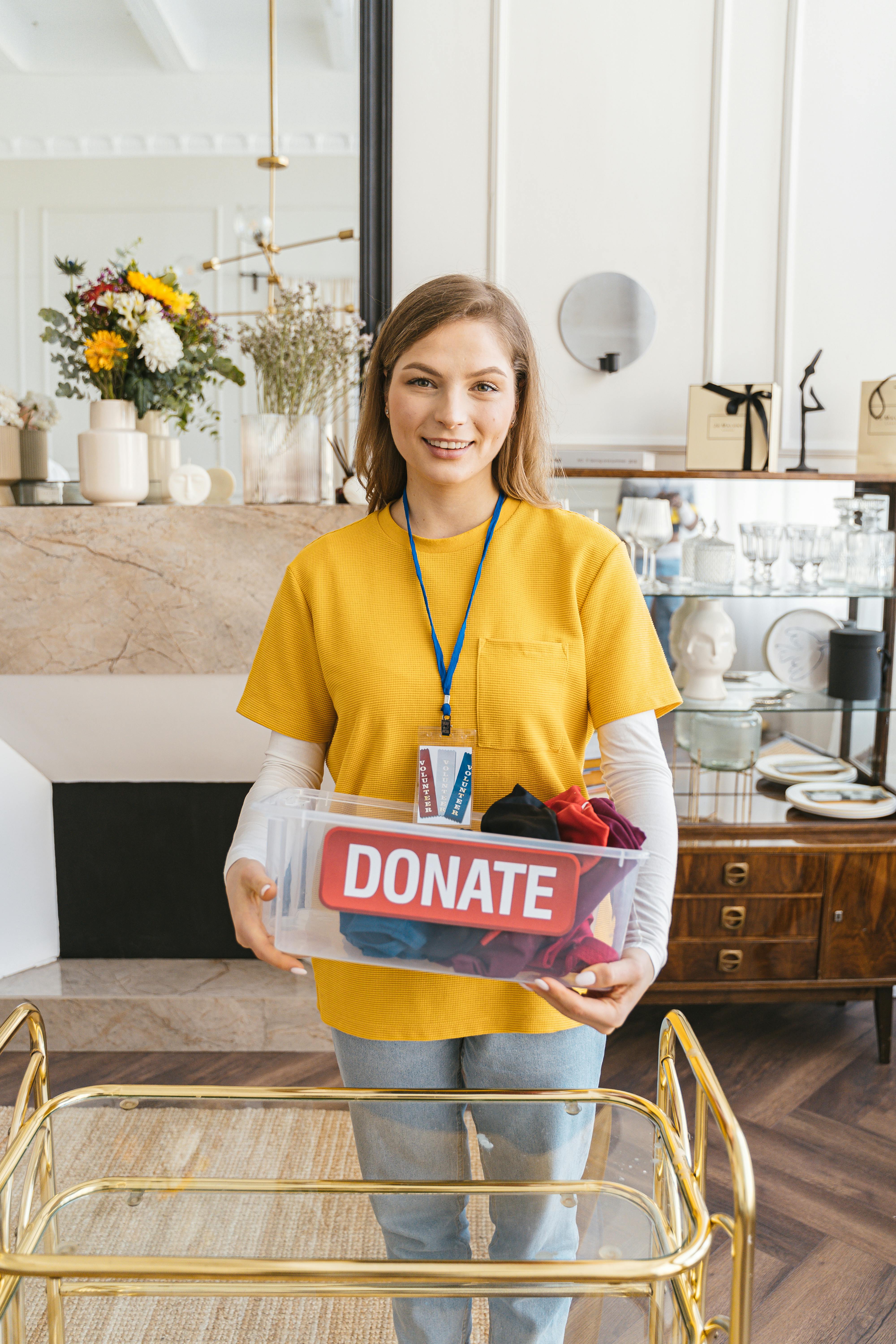 Portrait of Smiling Woman with Donation Box · Free Stock Photo