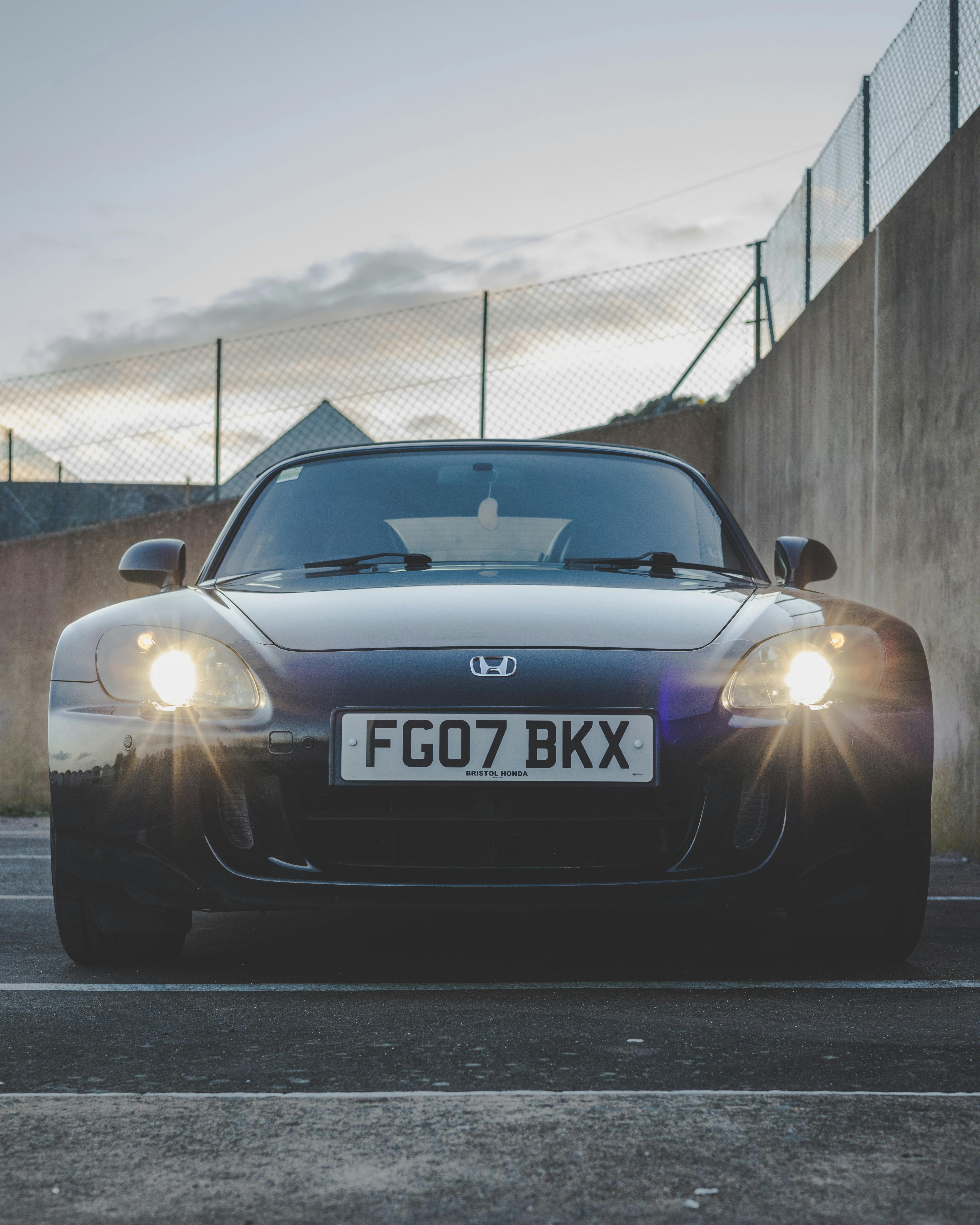 Car With Illuminated Headlights · Free Stock Photo