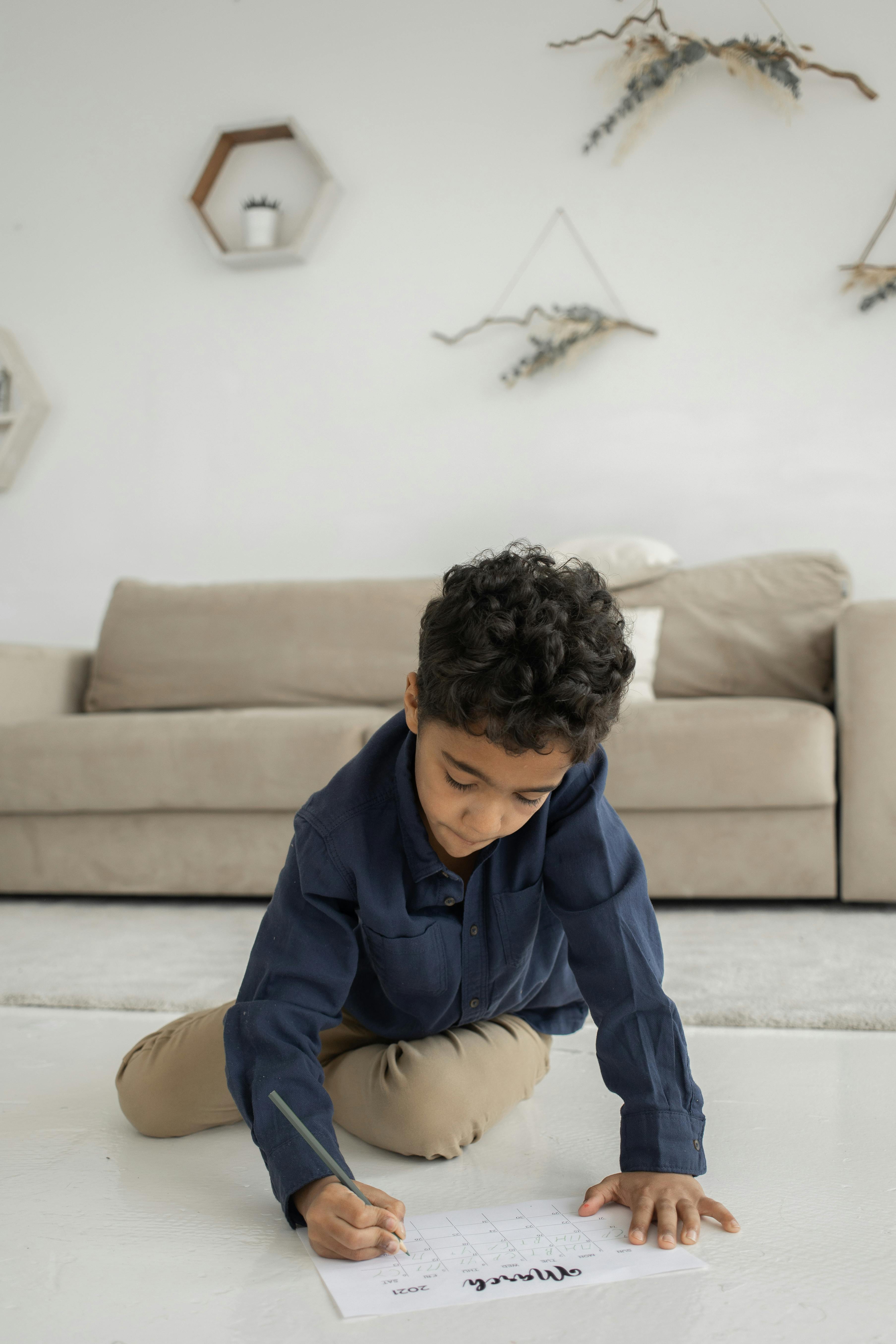 Black boy writing on paper · Free Stock Photo