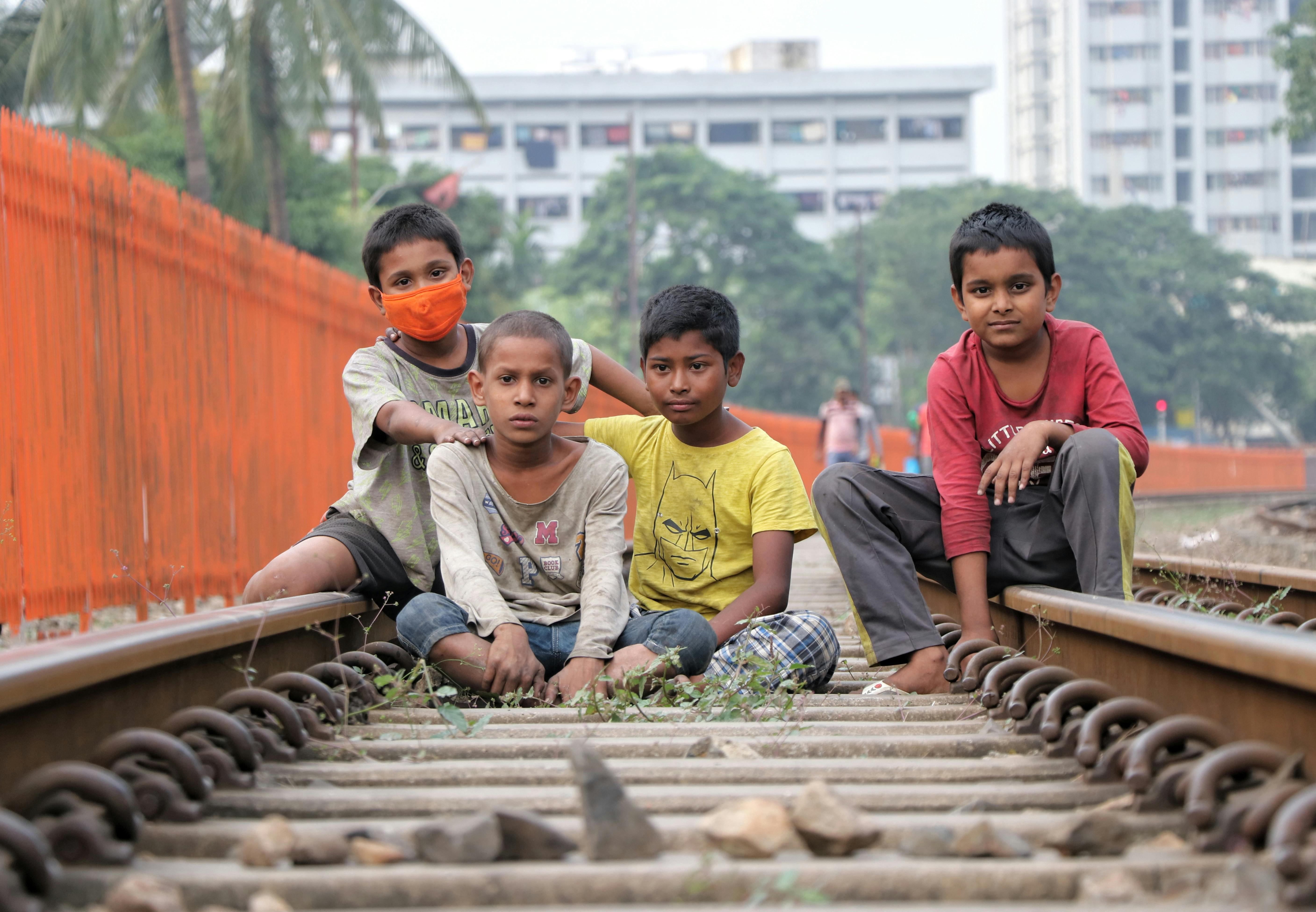Children Sitting on Rail Tracks · Free Stock Photo