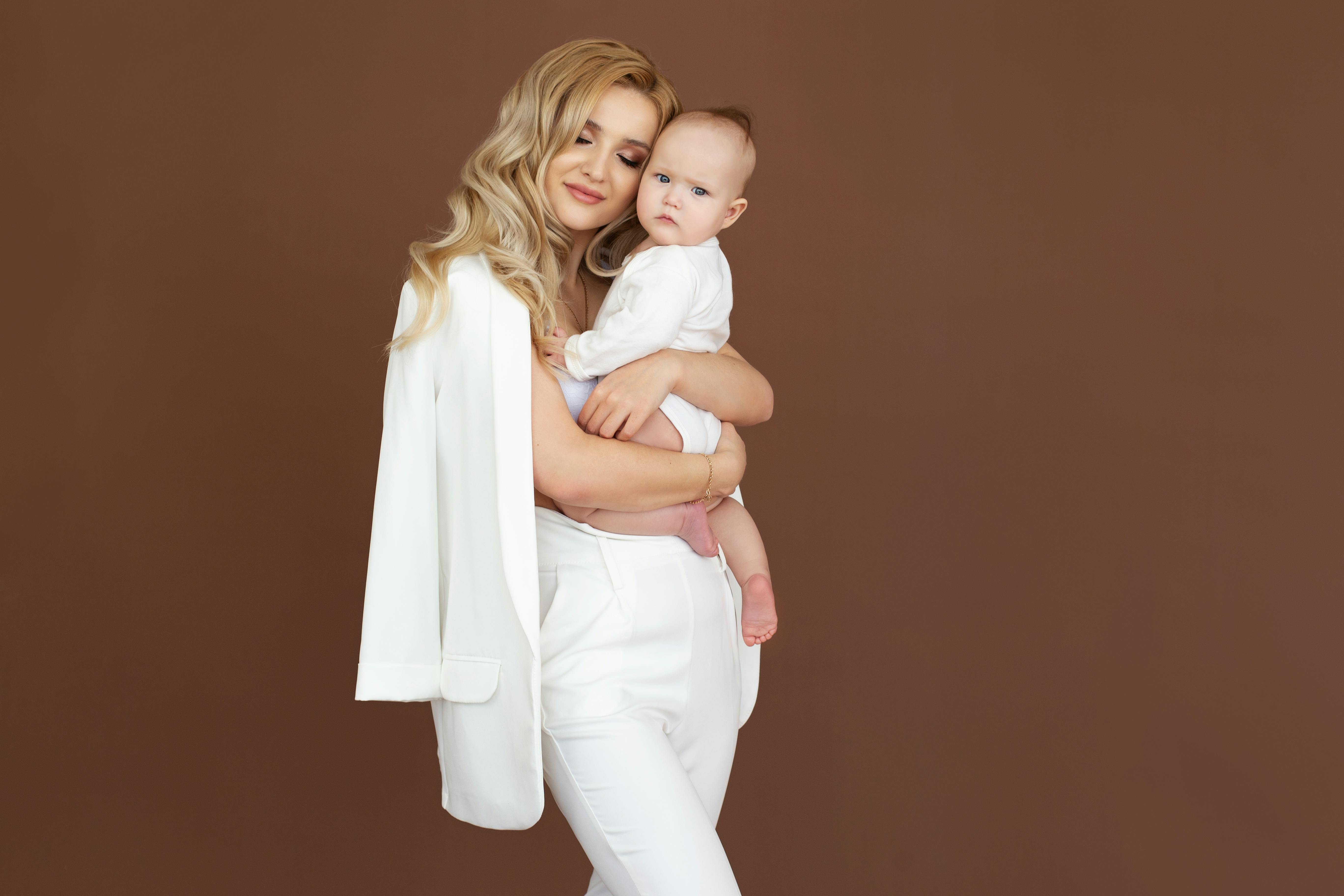Woman Hugging a Baby · Free Stock Photo