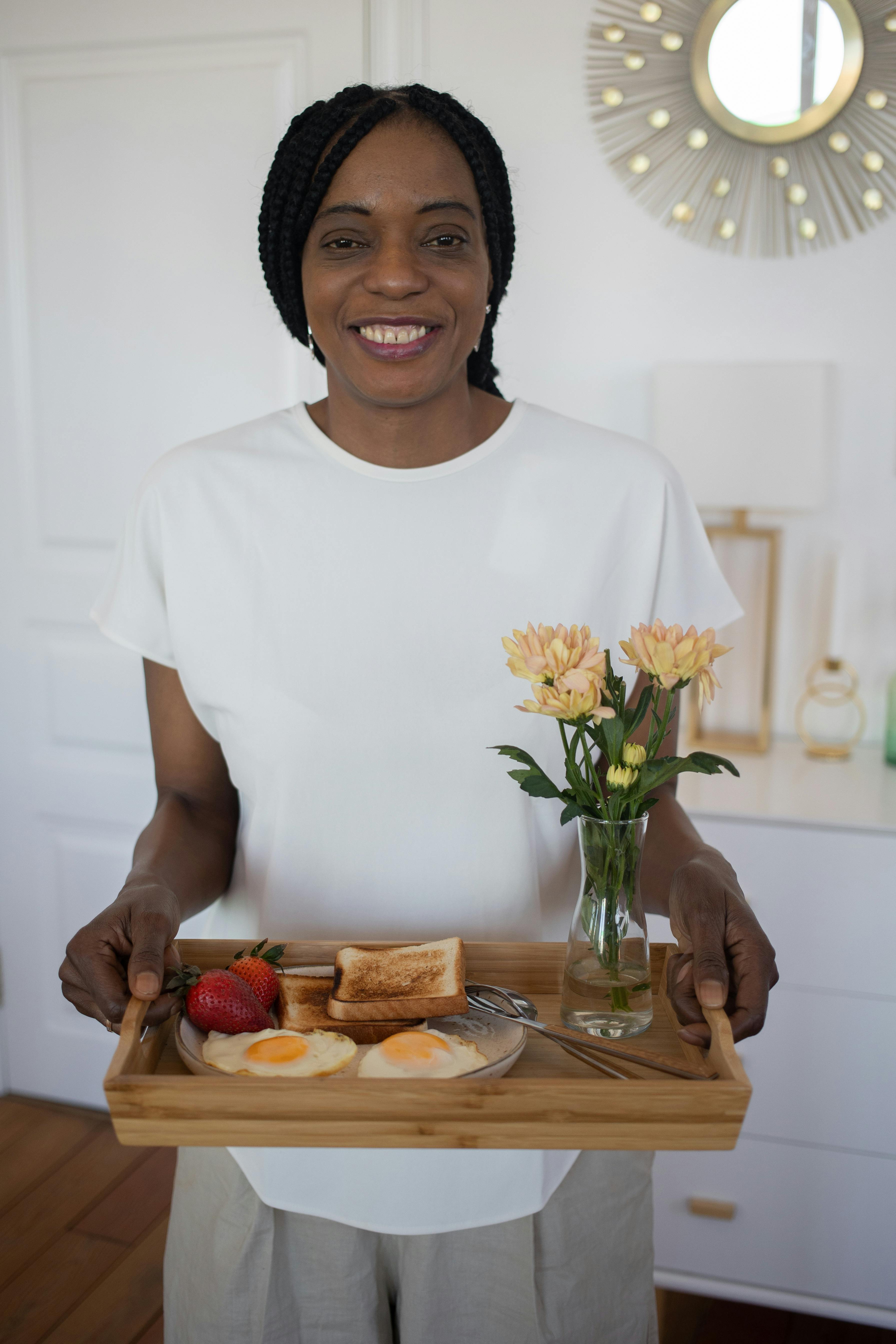 A Woman Carrying a Tray with Breakfast · Free Stock Photo