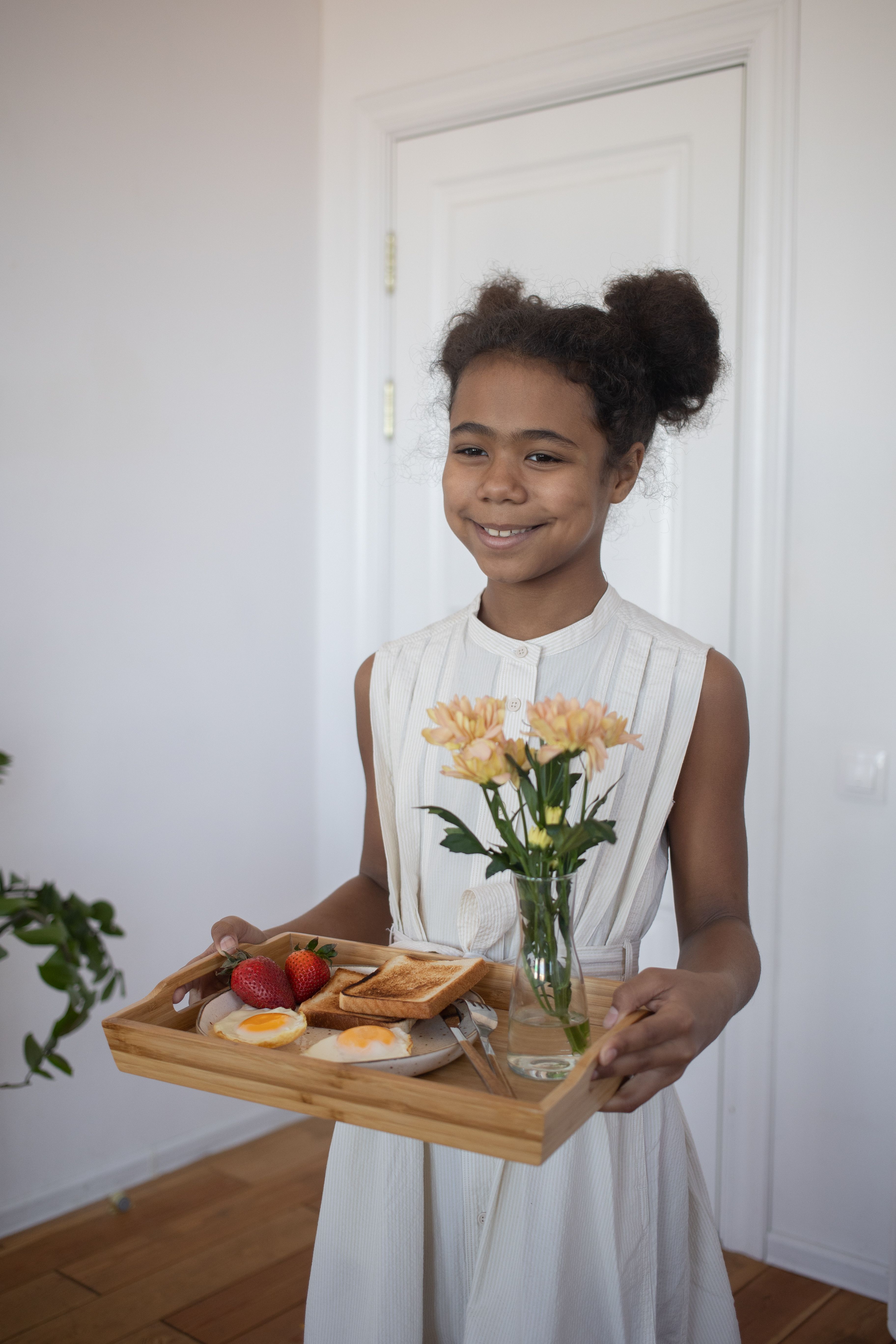 Smiling adult ethnic female worker serving cute girl in cafe · Free ...