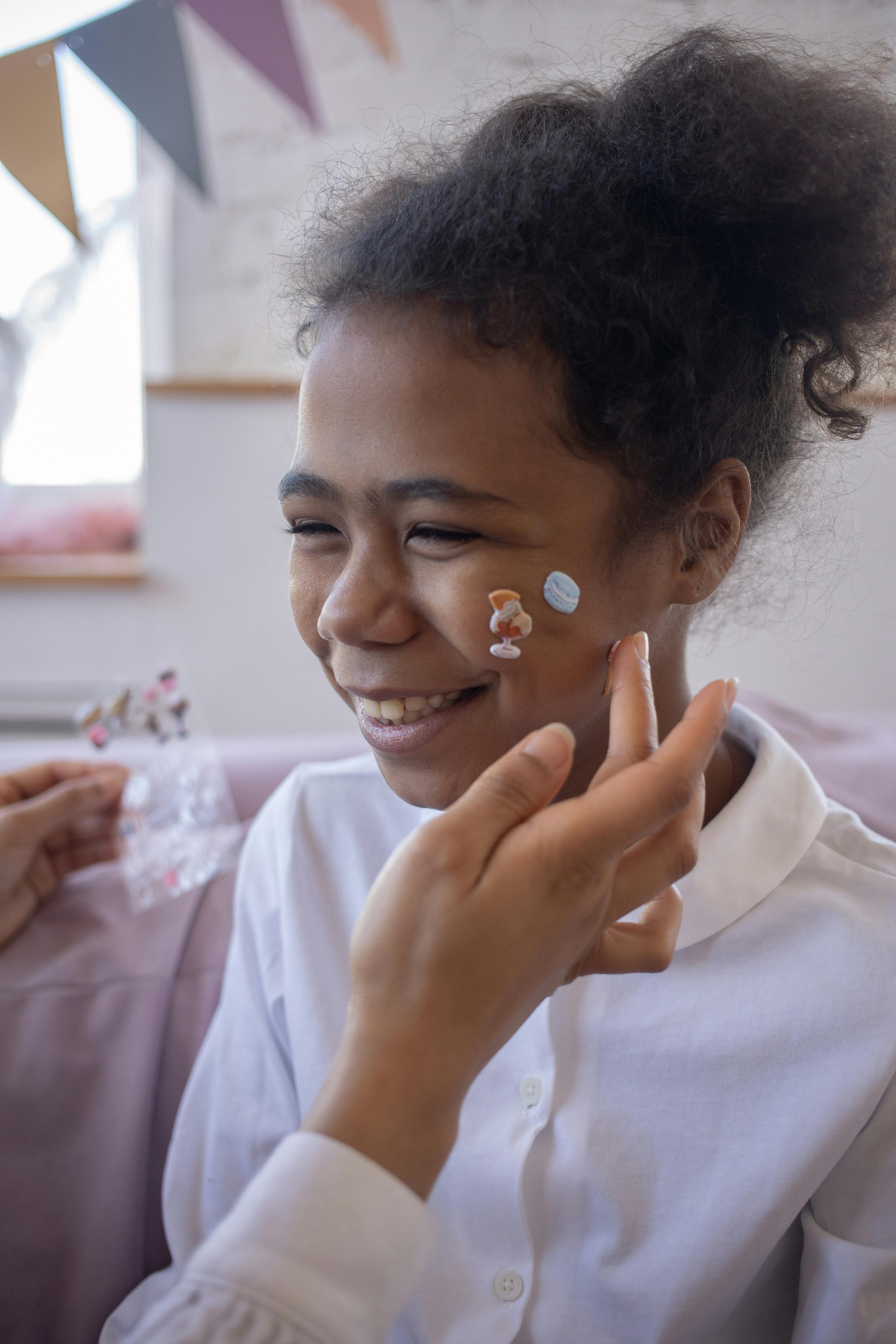 A Girl With Stickers on Her Face · Free Stock Photo