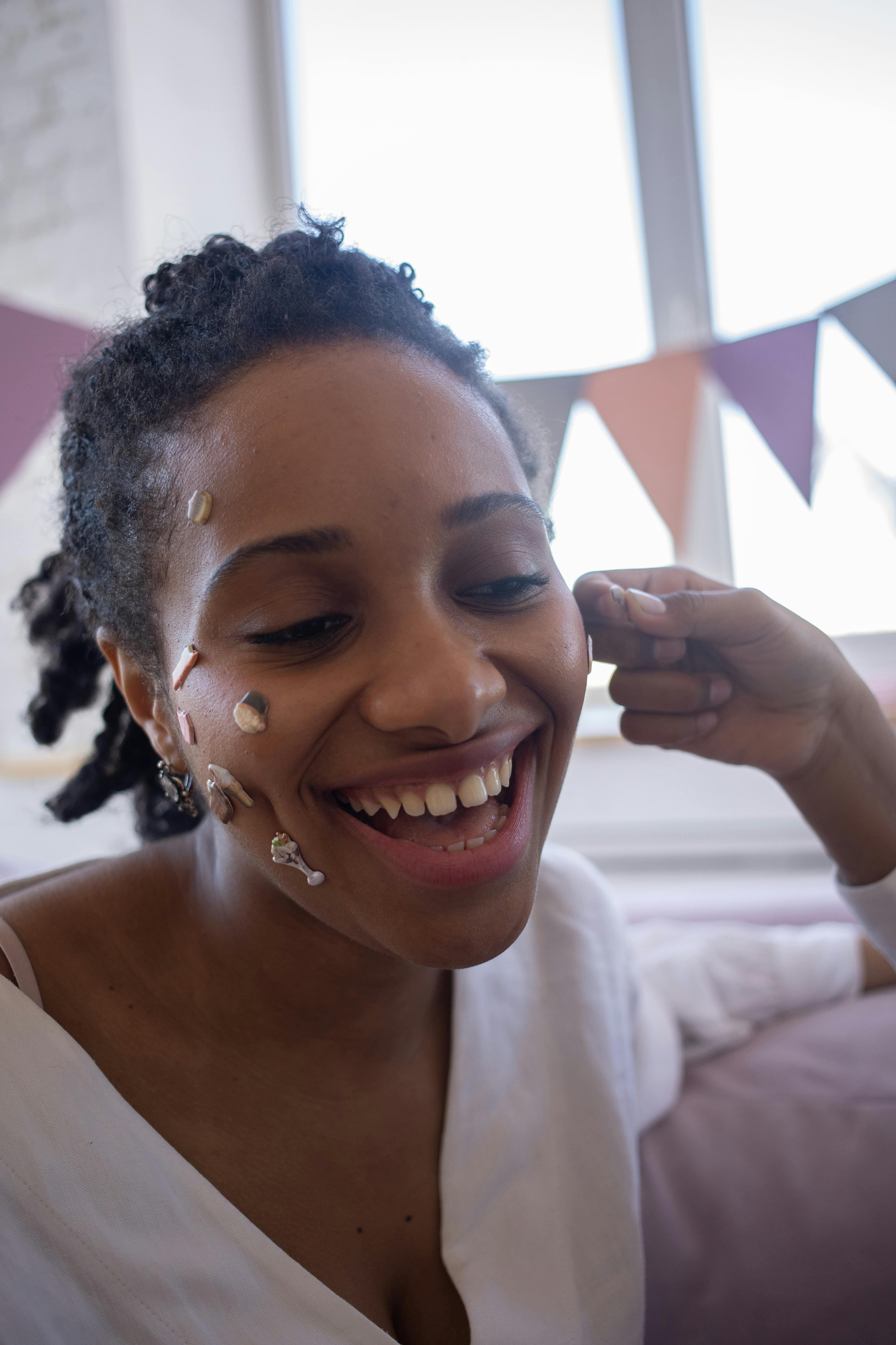 A Woman with Stickers on Her Face · Free Stock Photo