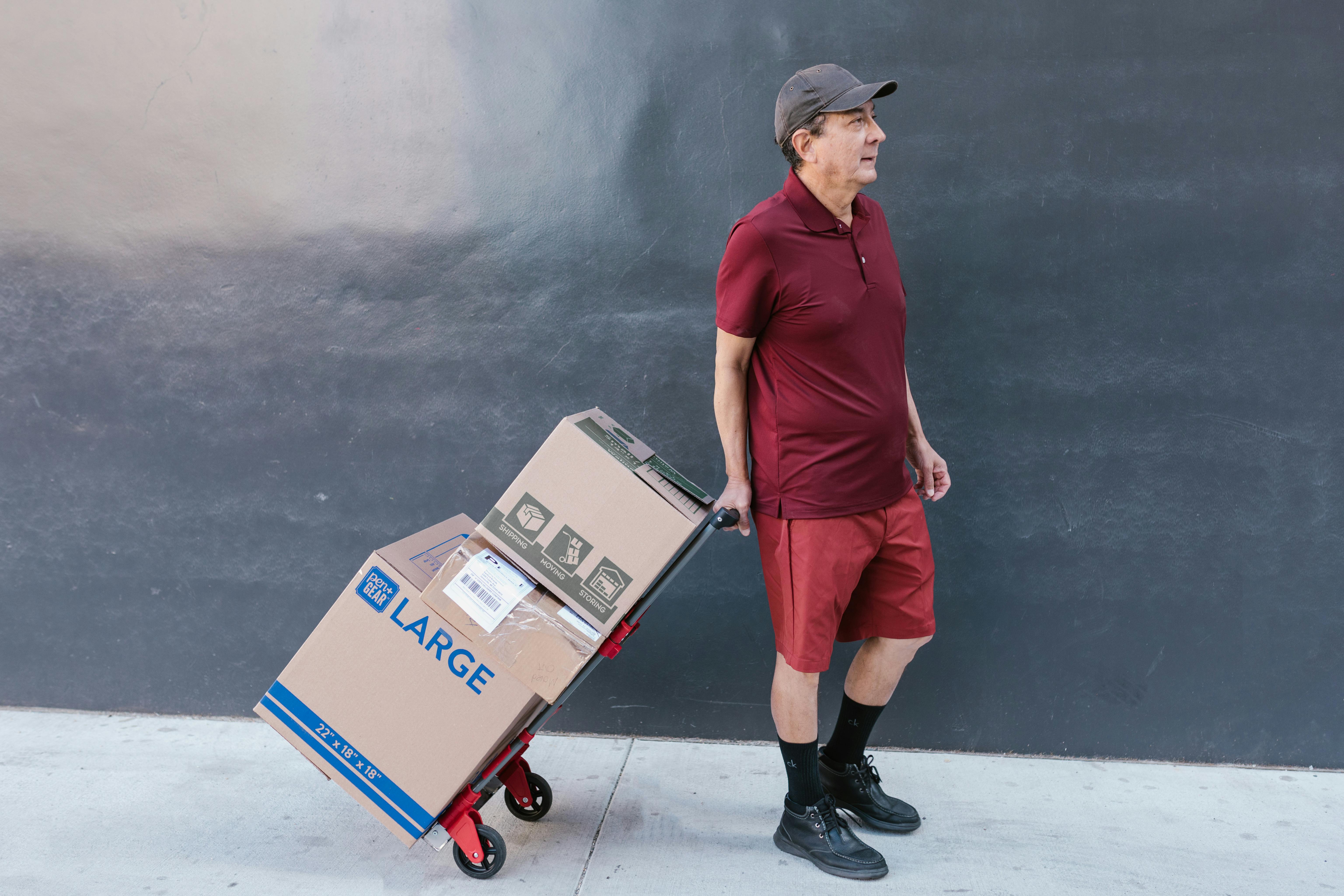 Man Pushing Trolley with Big Boxes · Free Stock Photo