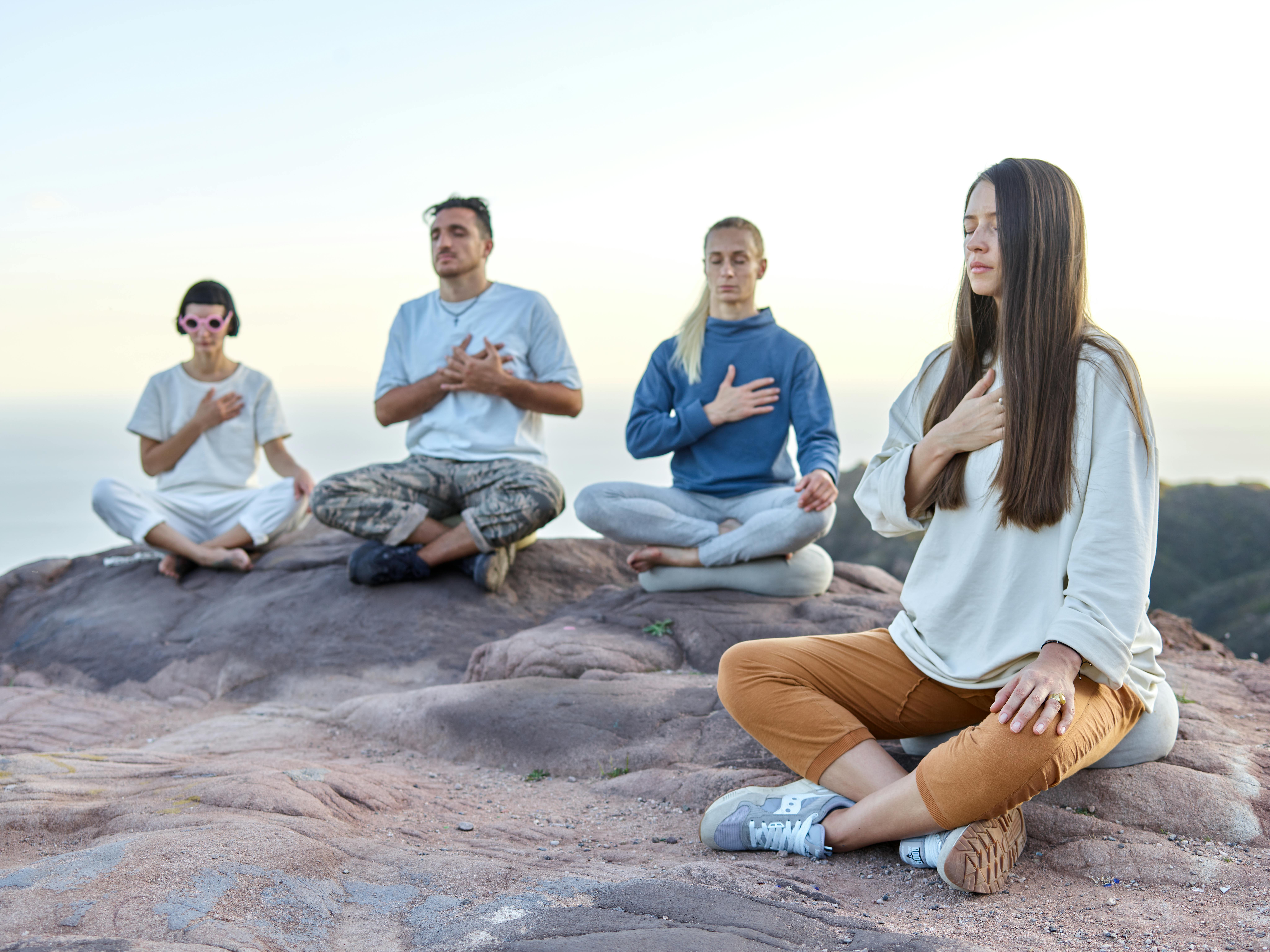 A Group of People Meditating on a Beach · Free Stock Photo